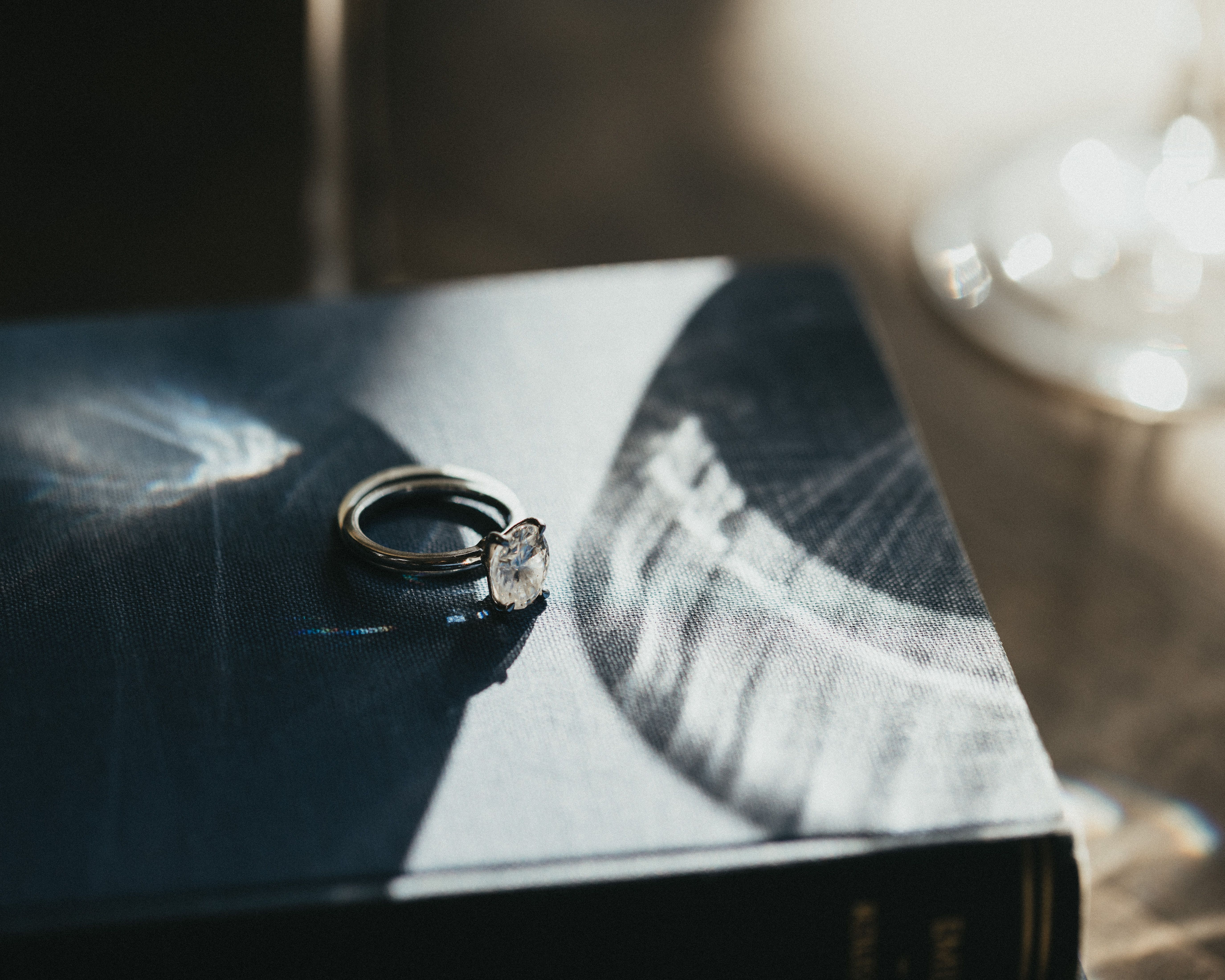 Engagement Ring on Vintage Book with Light Reflection · Free Stock Photo