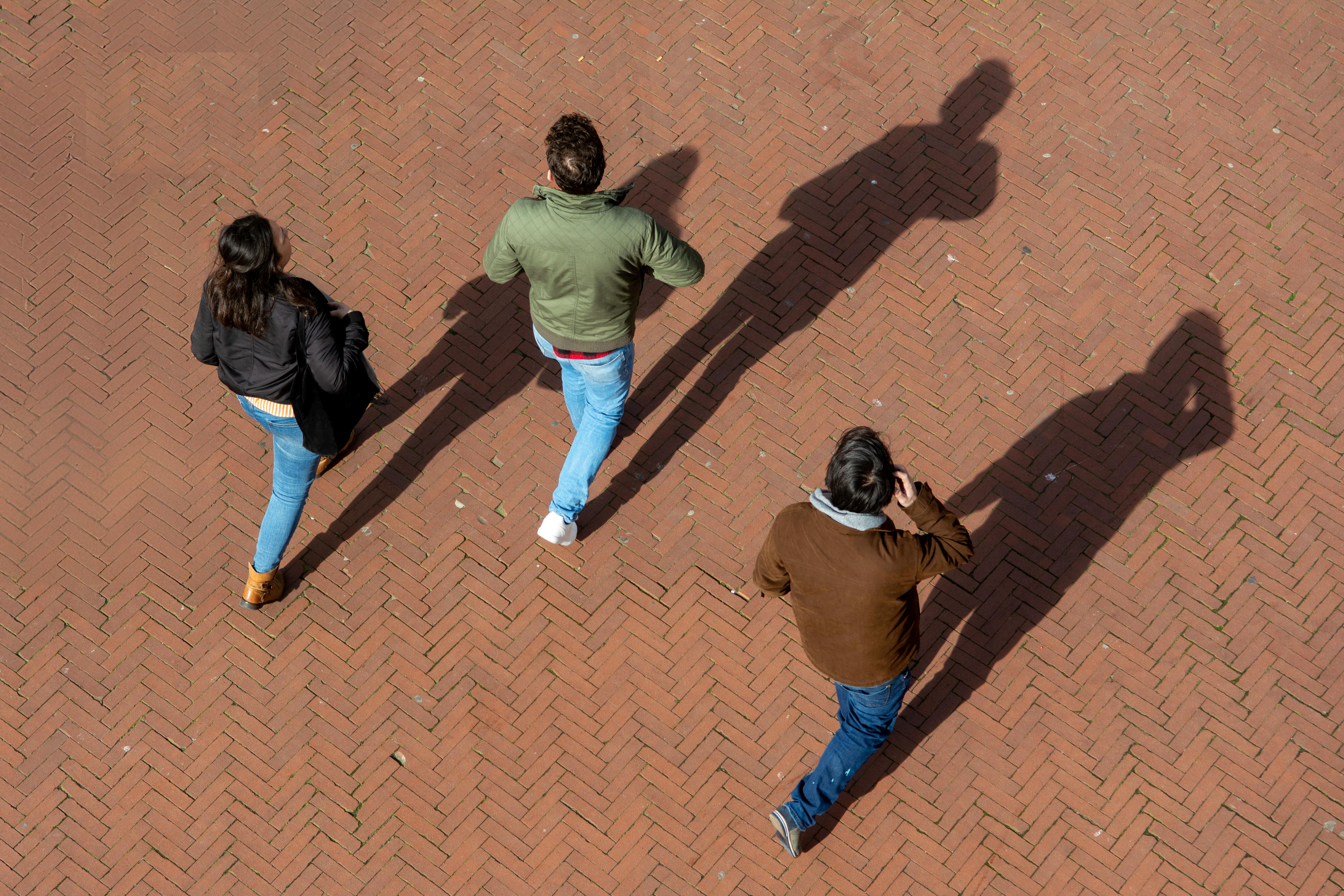 Aerial view of people walking on brick pavement · Free Stock Photo