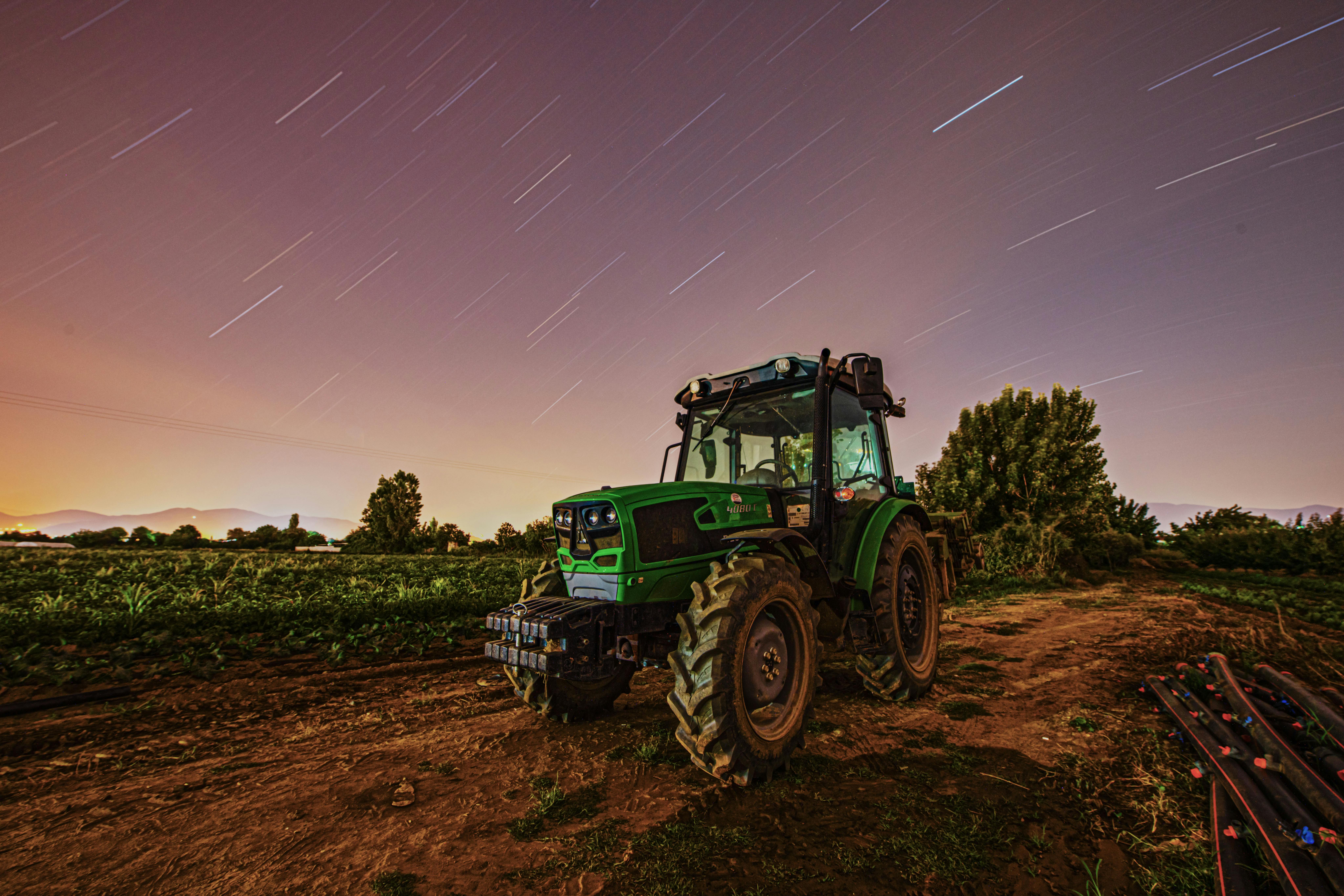 Starry Night Over Tractor in Open Field · Free Stock Photo