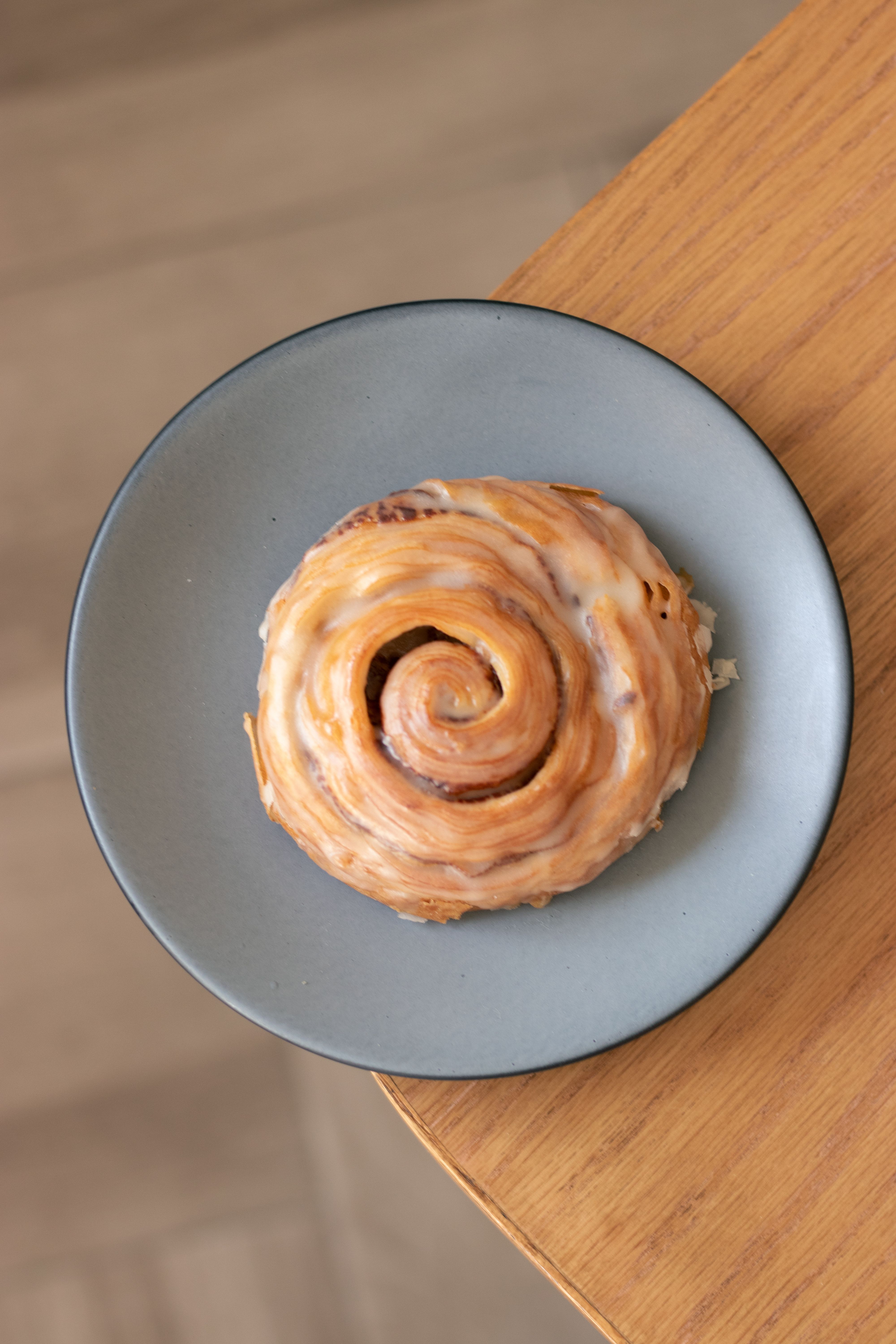 Delicious Glazed Cinnamon Roll on Plate · Free Stock Photo