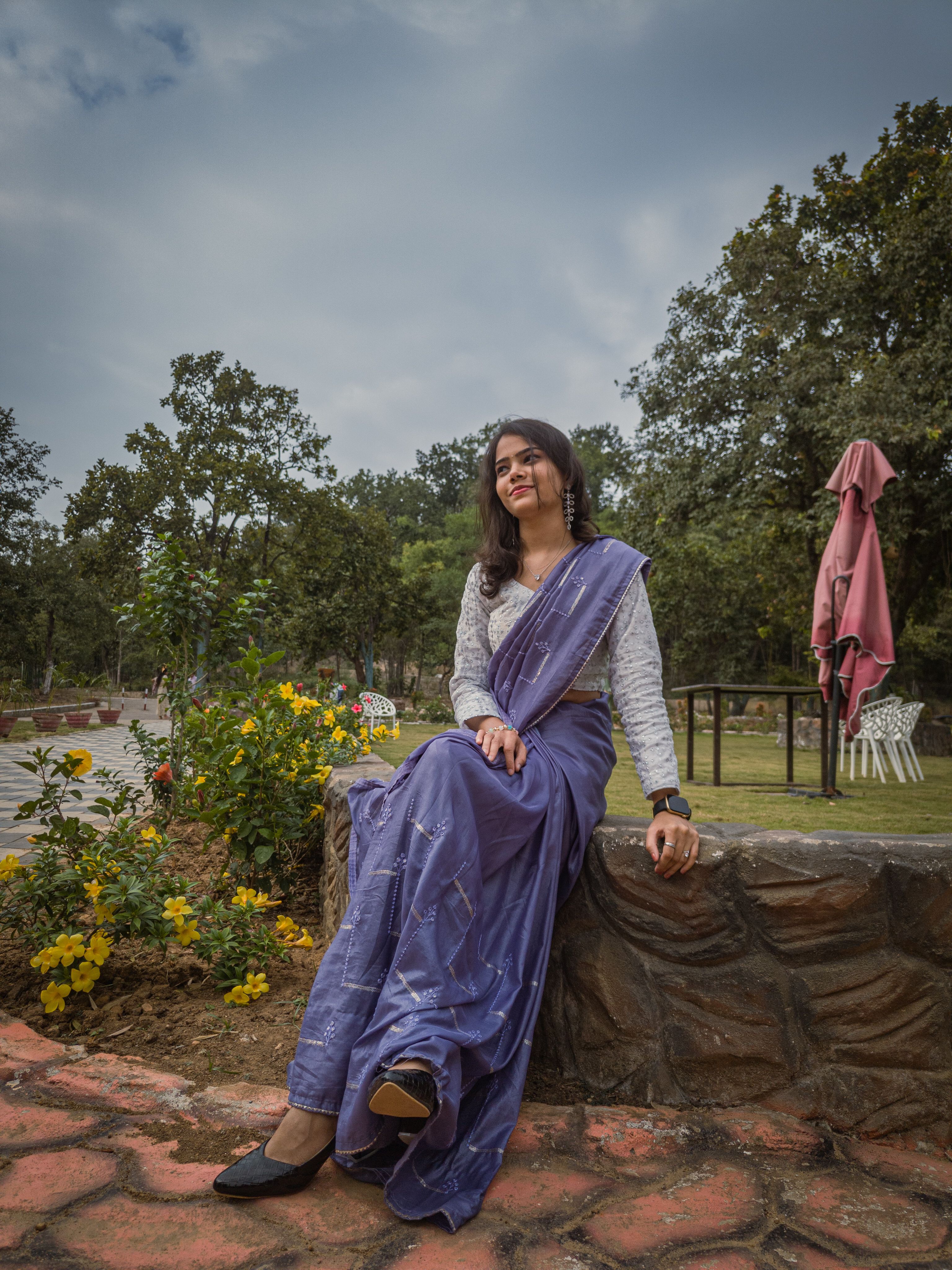 Woman in Traditional Sari Relaxing Outdoors · Free Stock Photo
