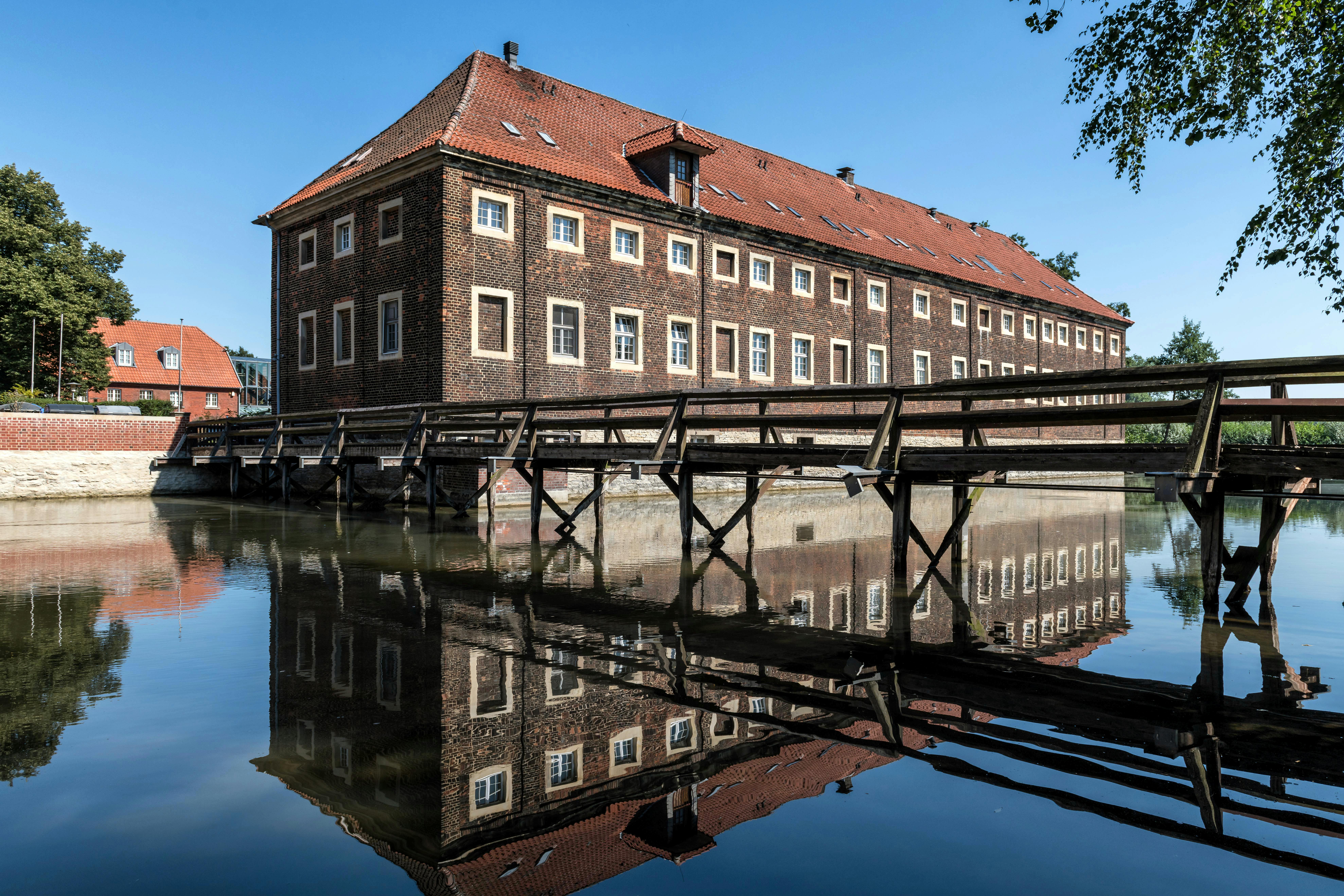 Historic German Castle Reflection on Tranquil Lake · Free Stock Photo