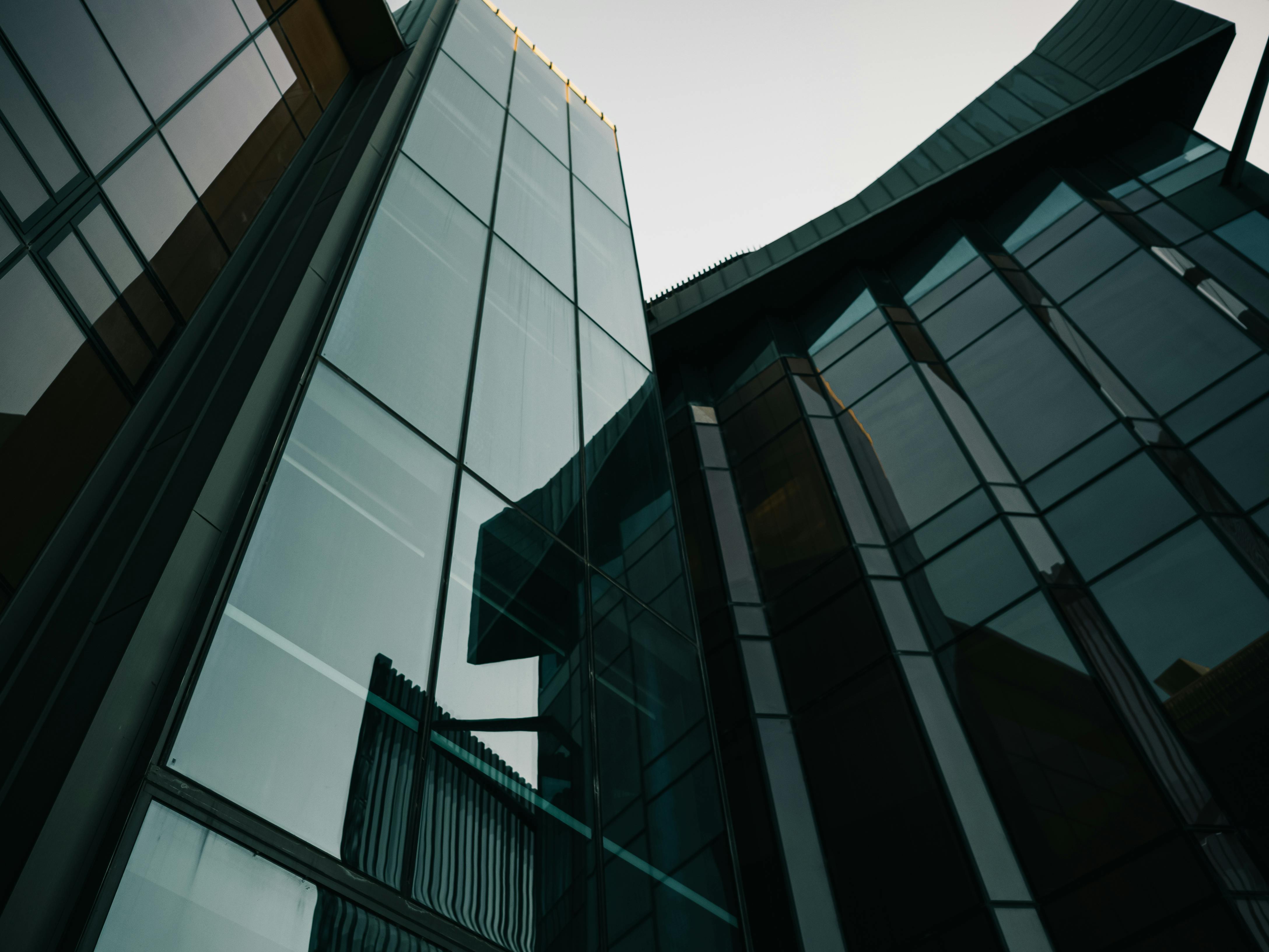 Modern Architectural Glass Facade in Urban Setting · Free Stock Photo