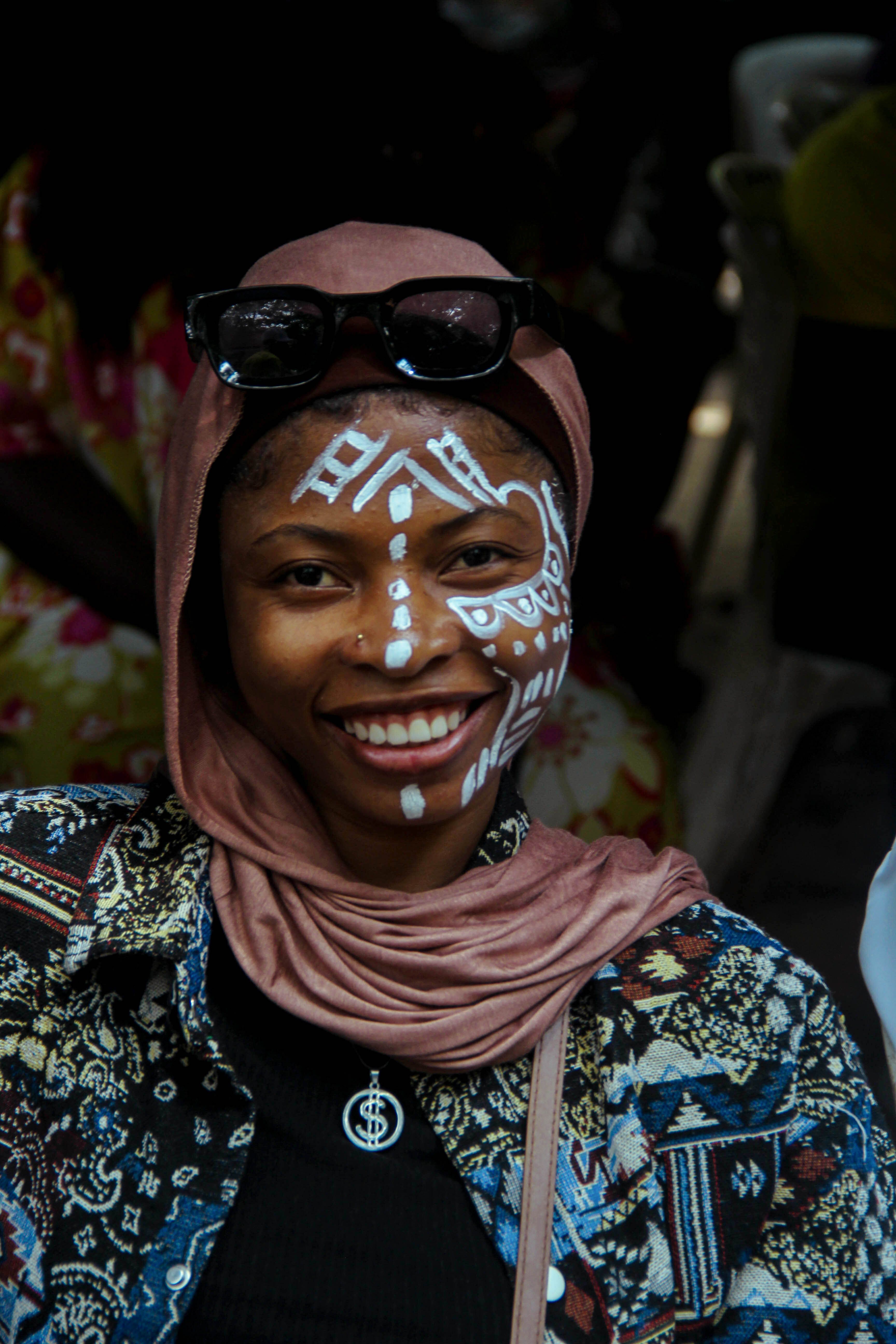 Smiling Woman with Traditional Face Paint in Nigeria · Free Stock Photo