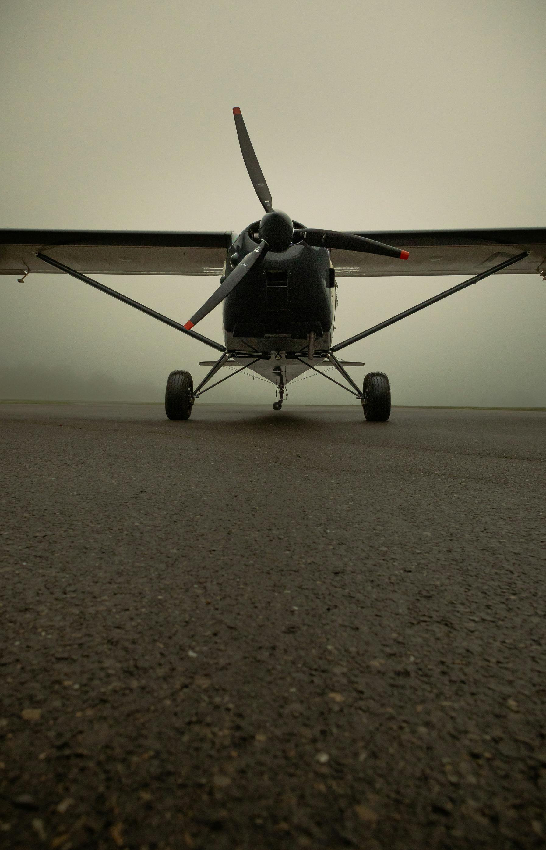 Front View of Small Aircraft on Foggy Runway · Free Stock Photo