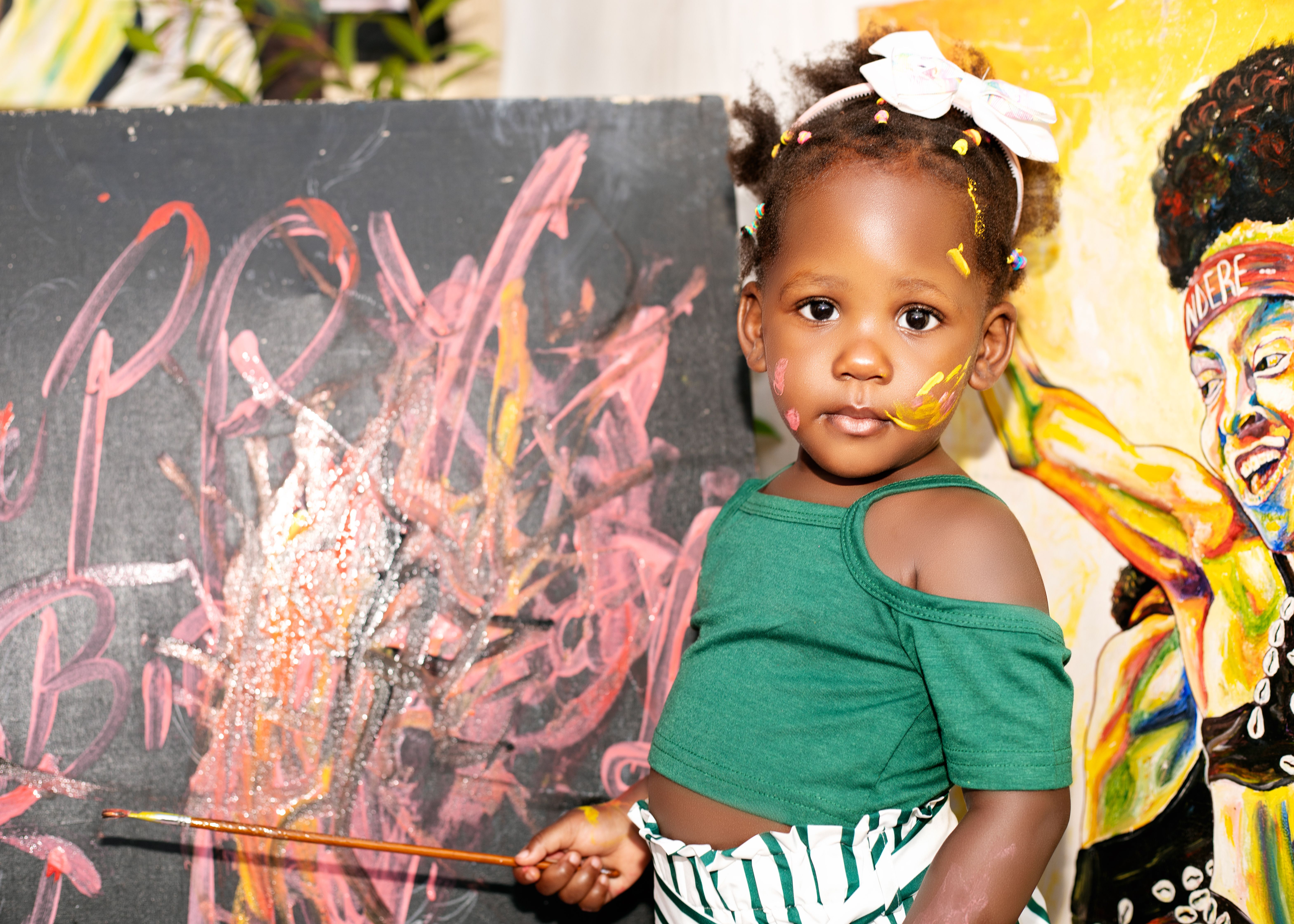 Adorable Child Artist with Colorful Paintings · Free Stock Photo