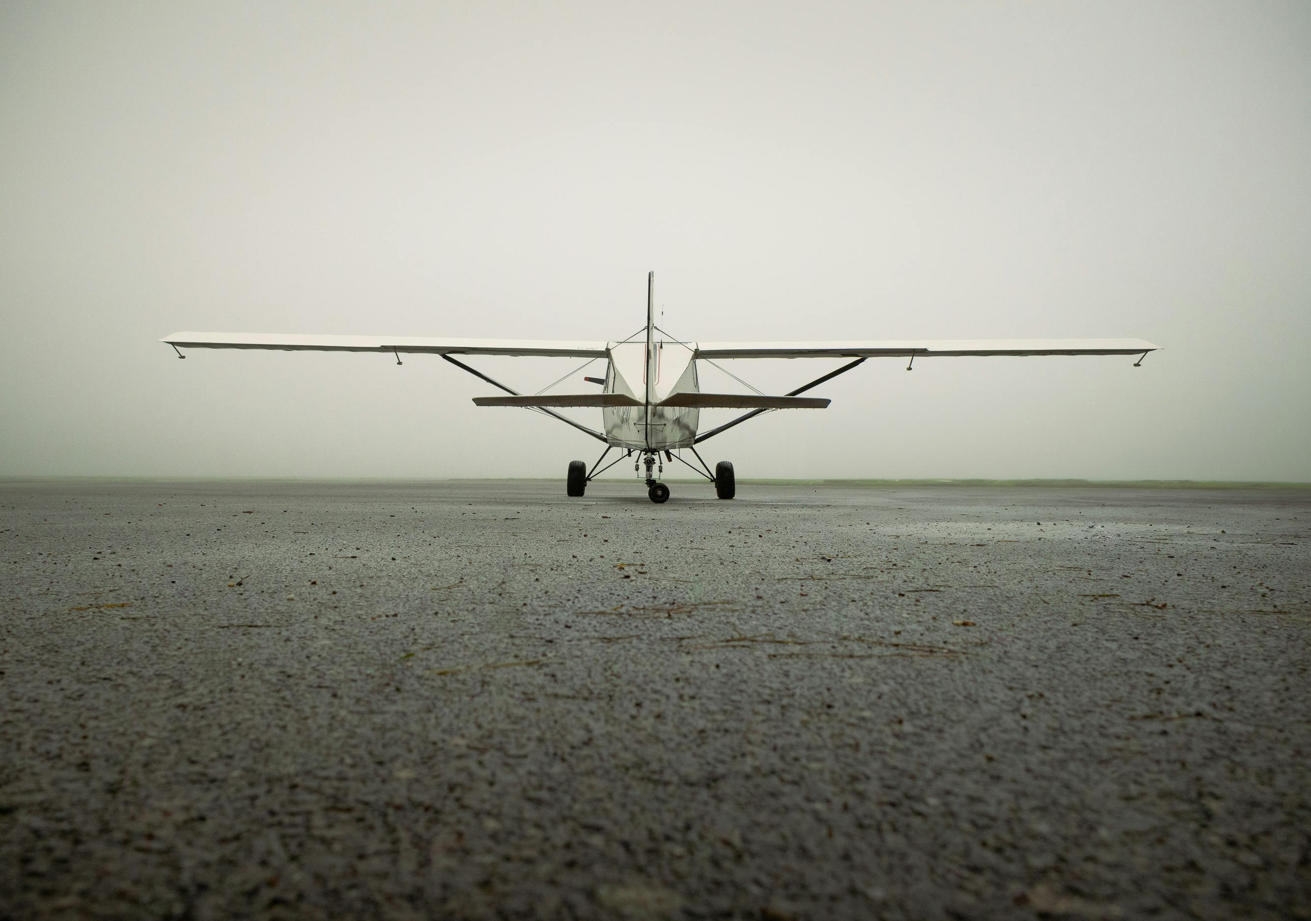 Small Aircraft on Foggy Runway · Free Stock Photo