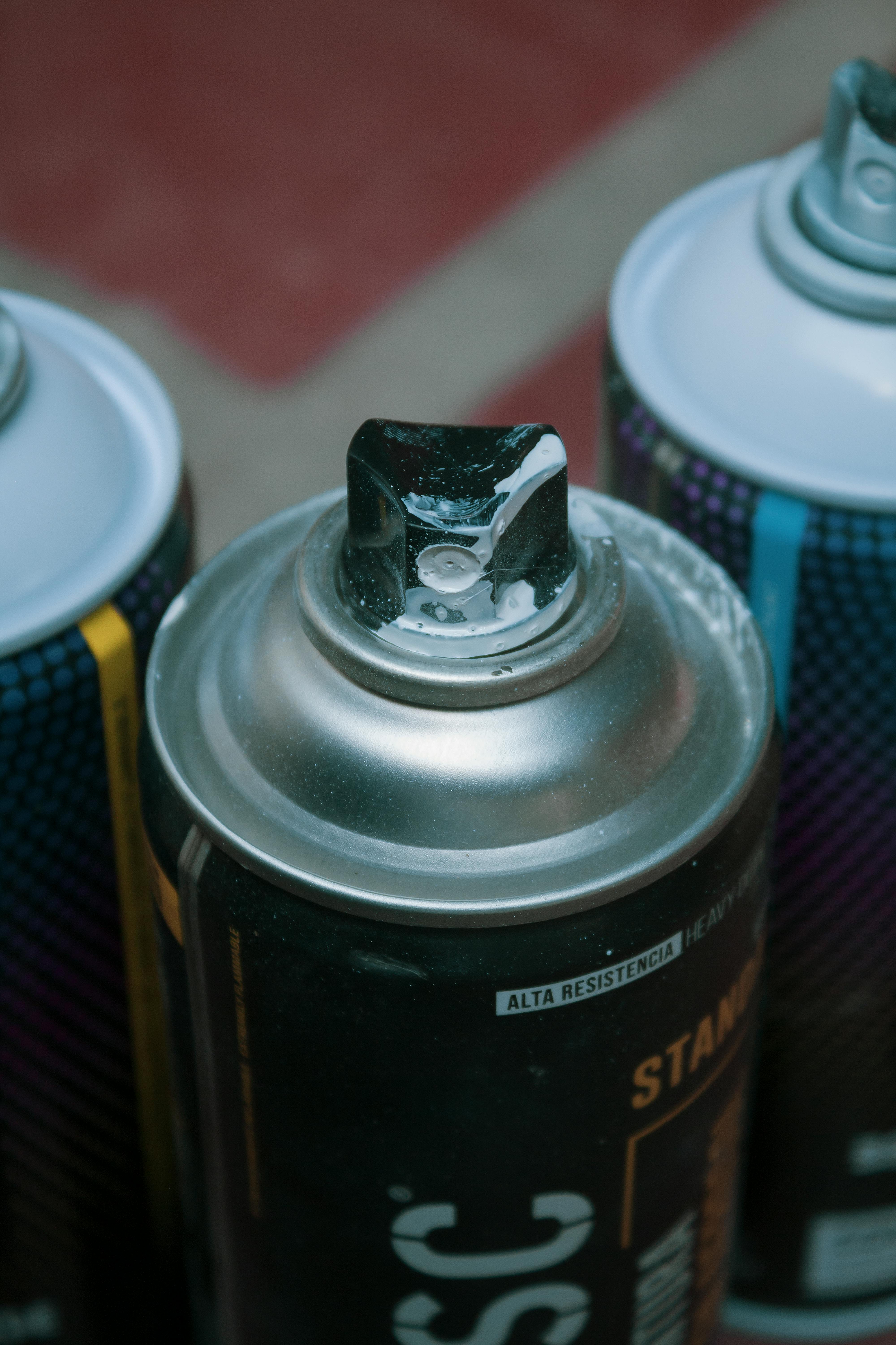 Close-Up of Spray Paint Cans Outdoors · Free Stock Photo