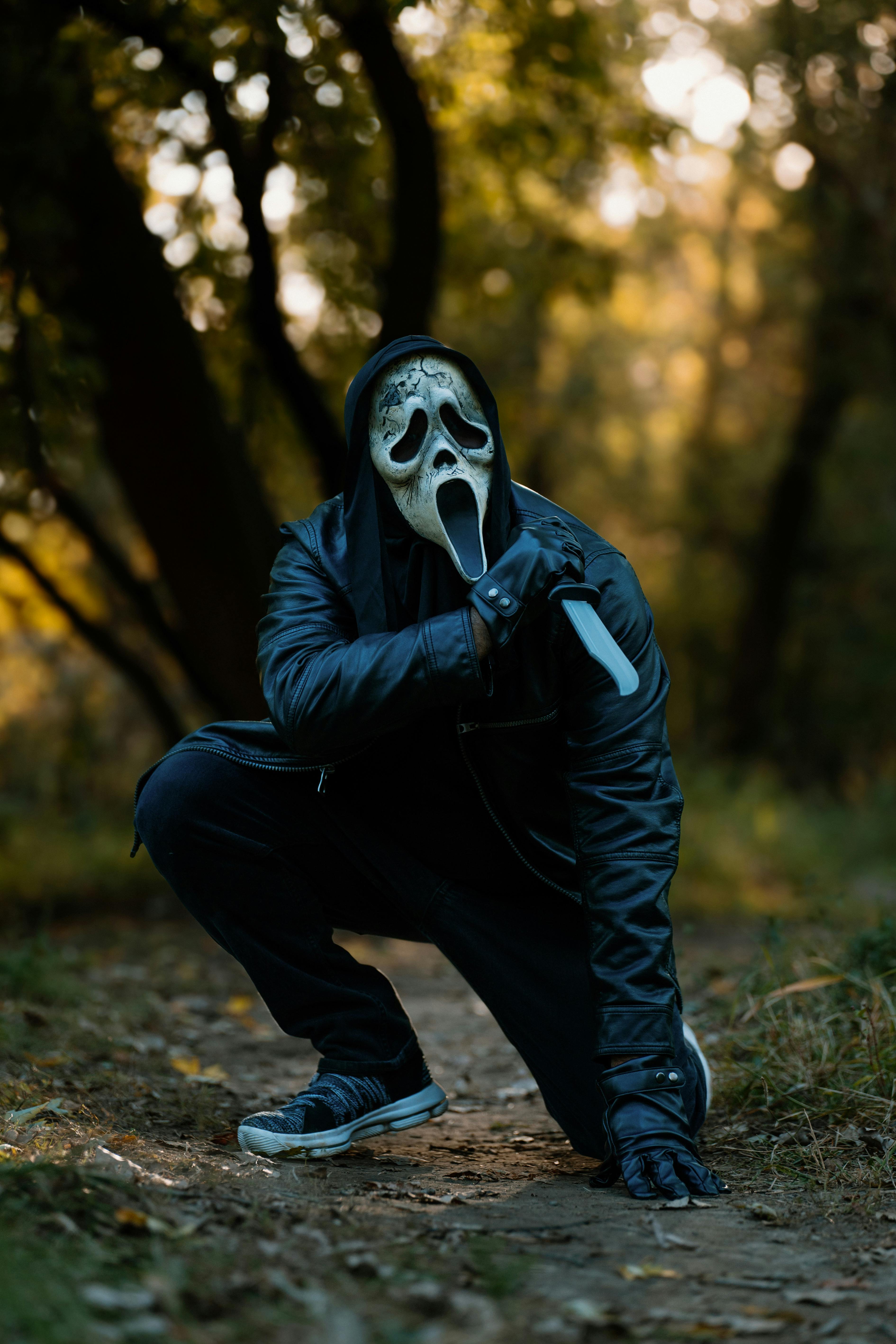 Horror Masked Figure in Spooky Forest Setting · Free Stock Photo
