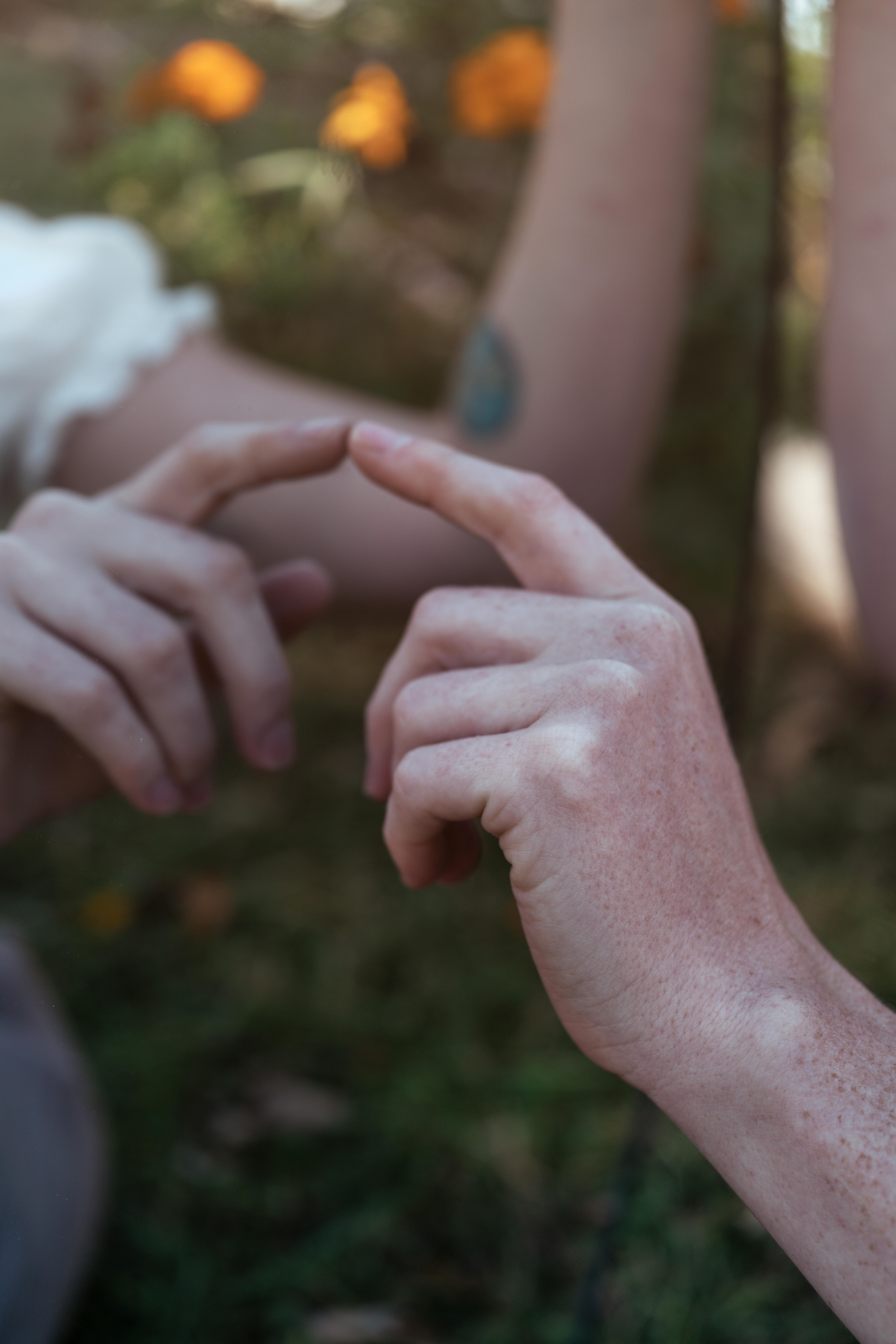Close-Up of Hands Touching Outdoors · Free Stock Photo