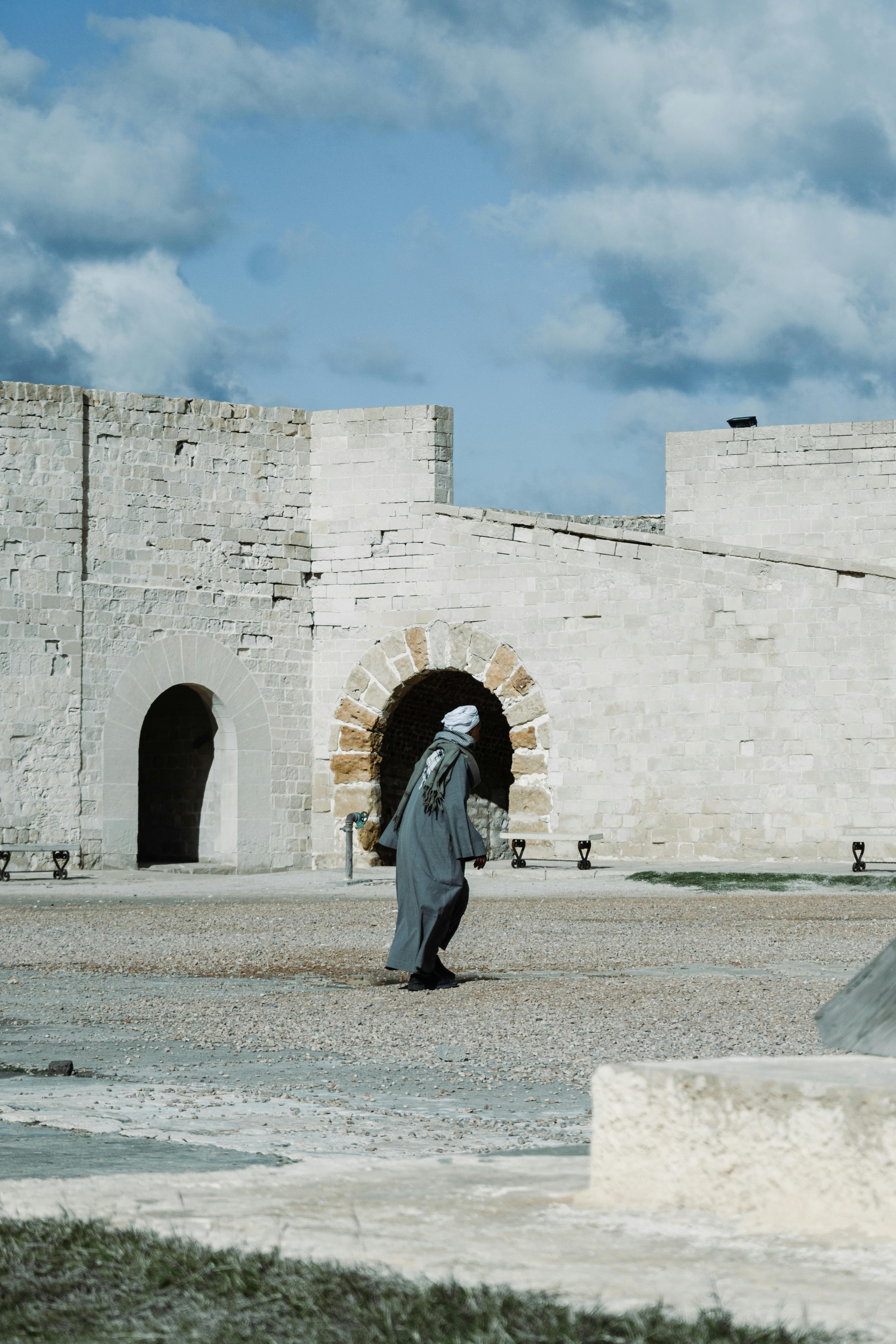 Historic Stone Fortress with Lone Figure · Free Stock Photo