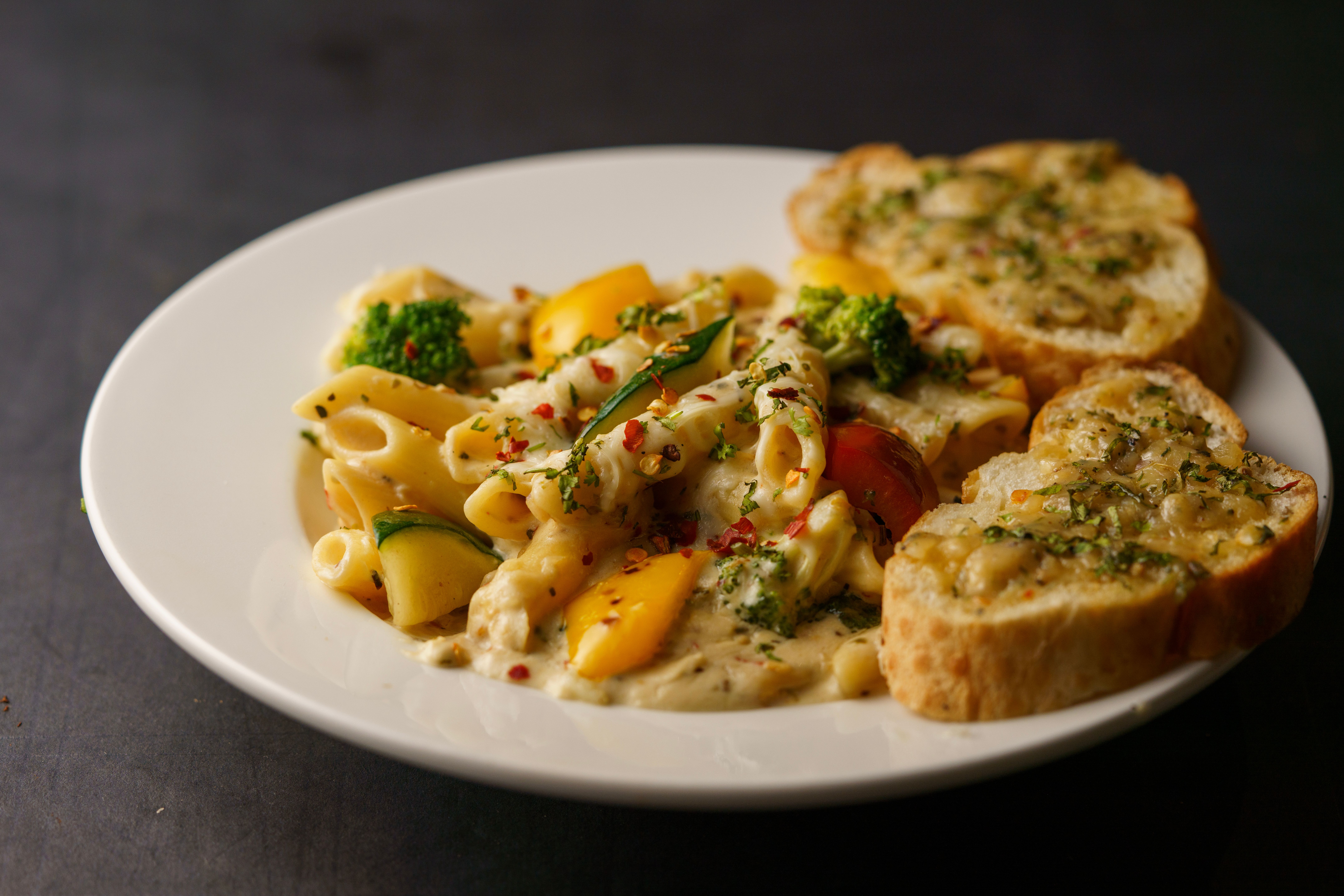 Gourmet Penne Pasta with Garlic Bread · Free Stock Photo