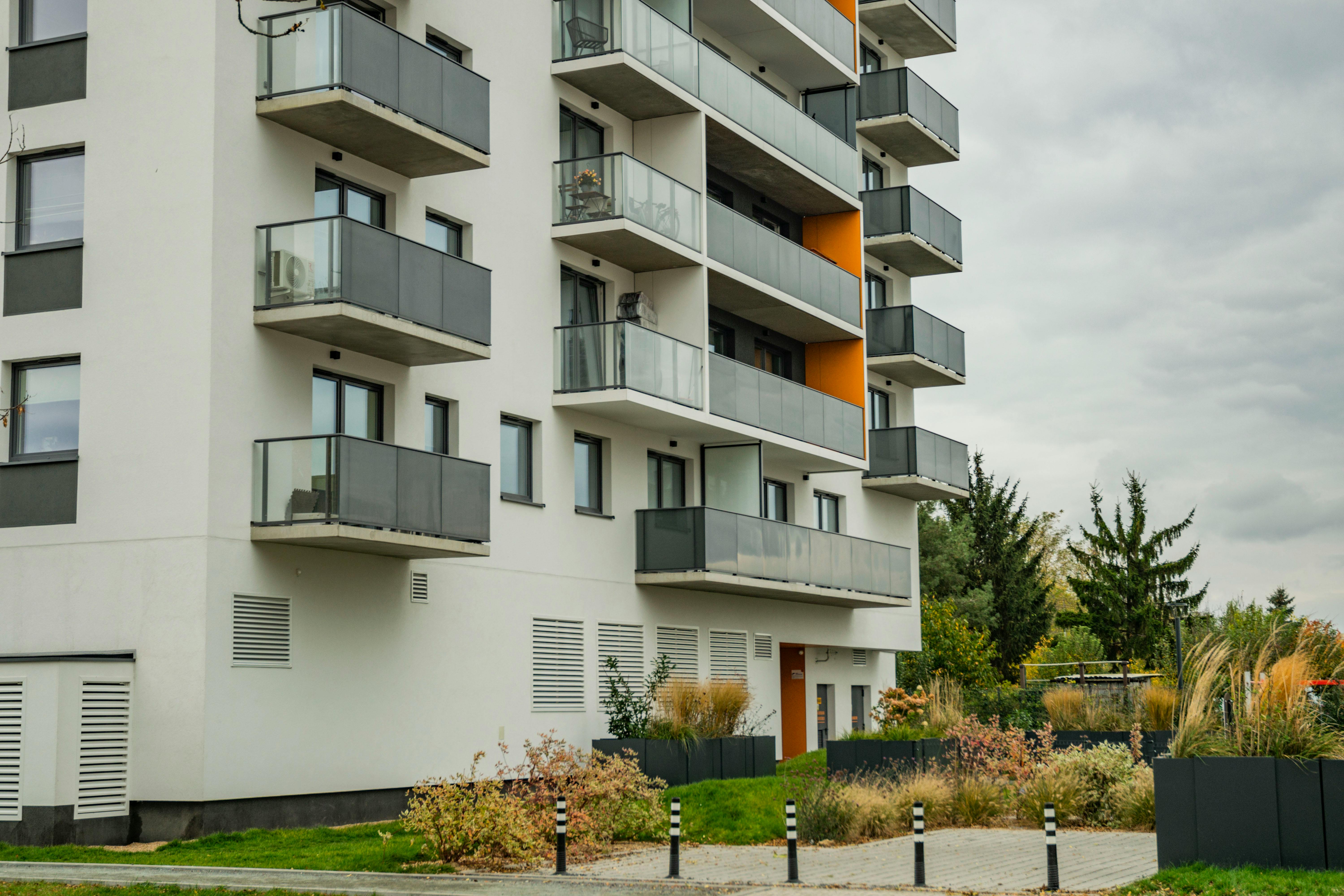 Modern Apartment Building with Glass Balconies · Free Stock Photo