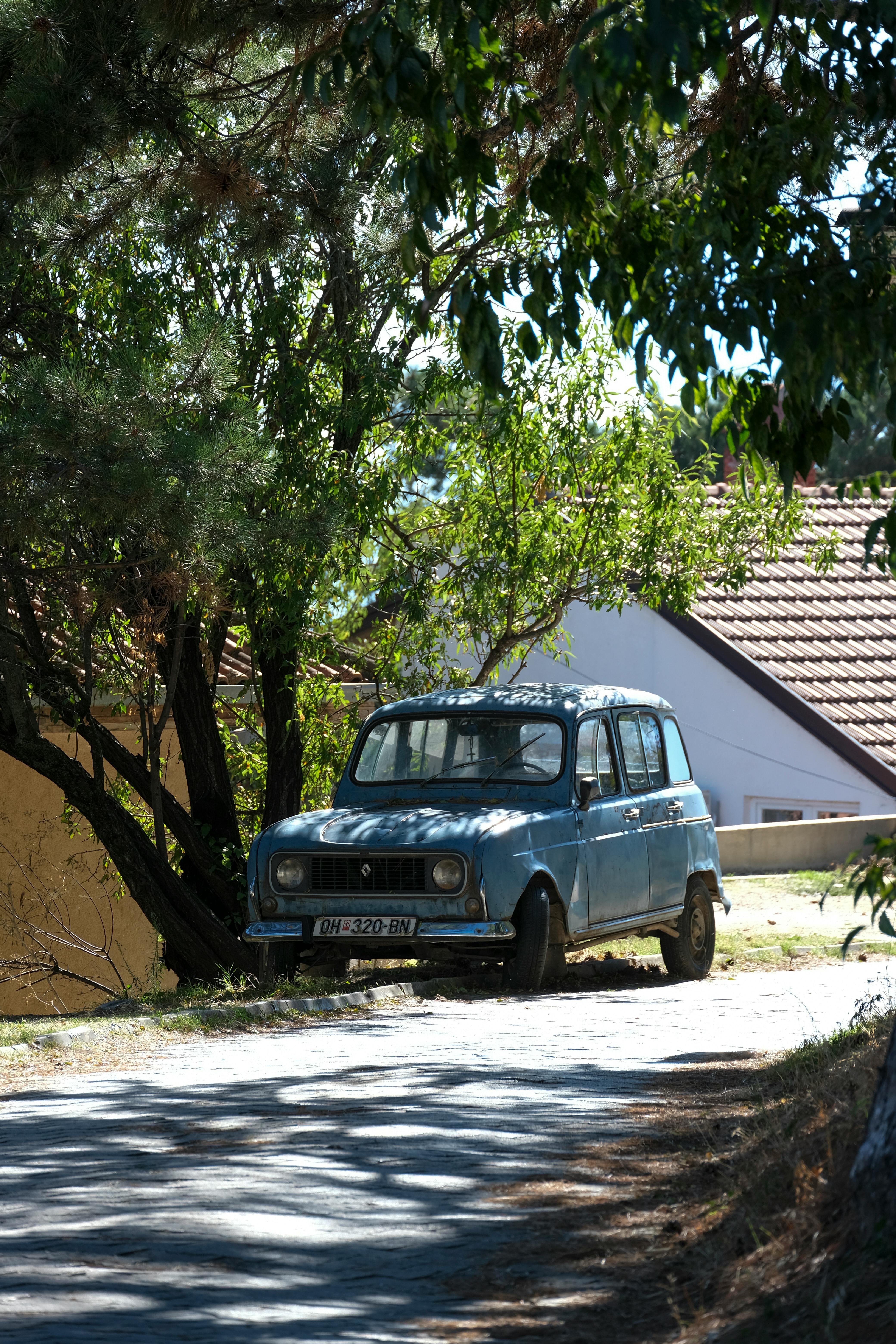 Vintage Blue Car Parked on Sunny Rural Road · Free Stock Photo