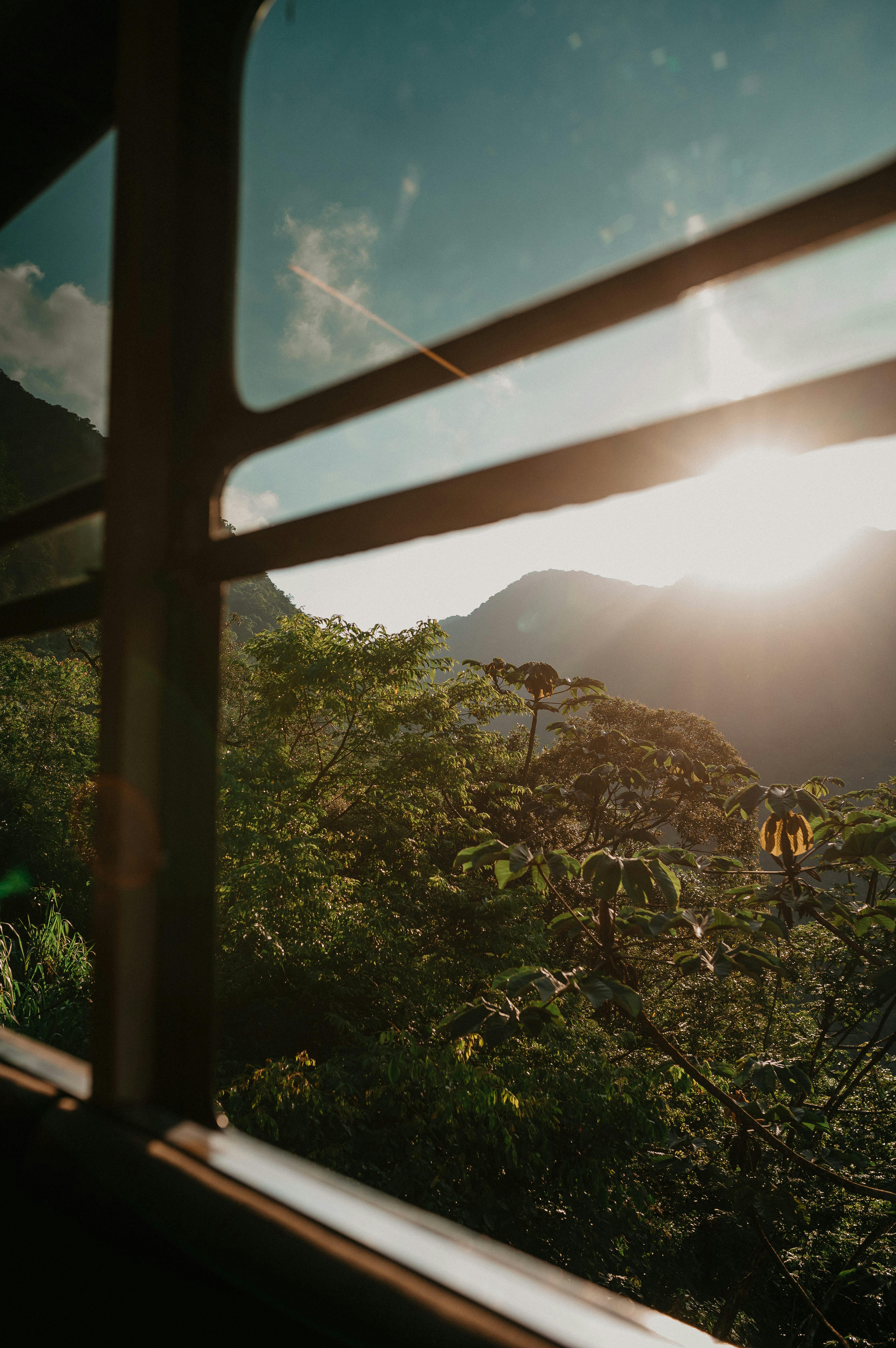Scenic Mountain View Through Train Window at Sunset · Free Stock Photo