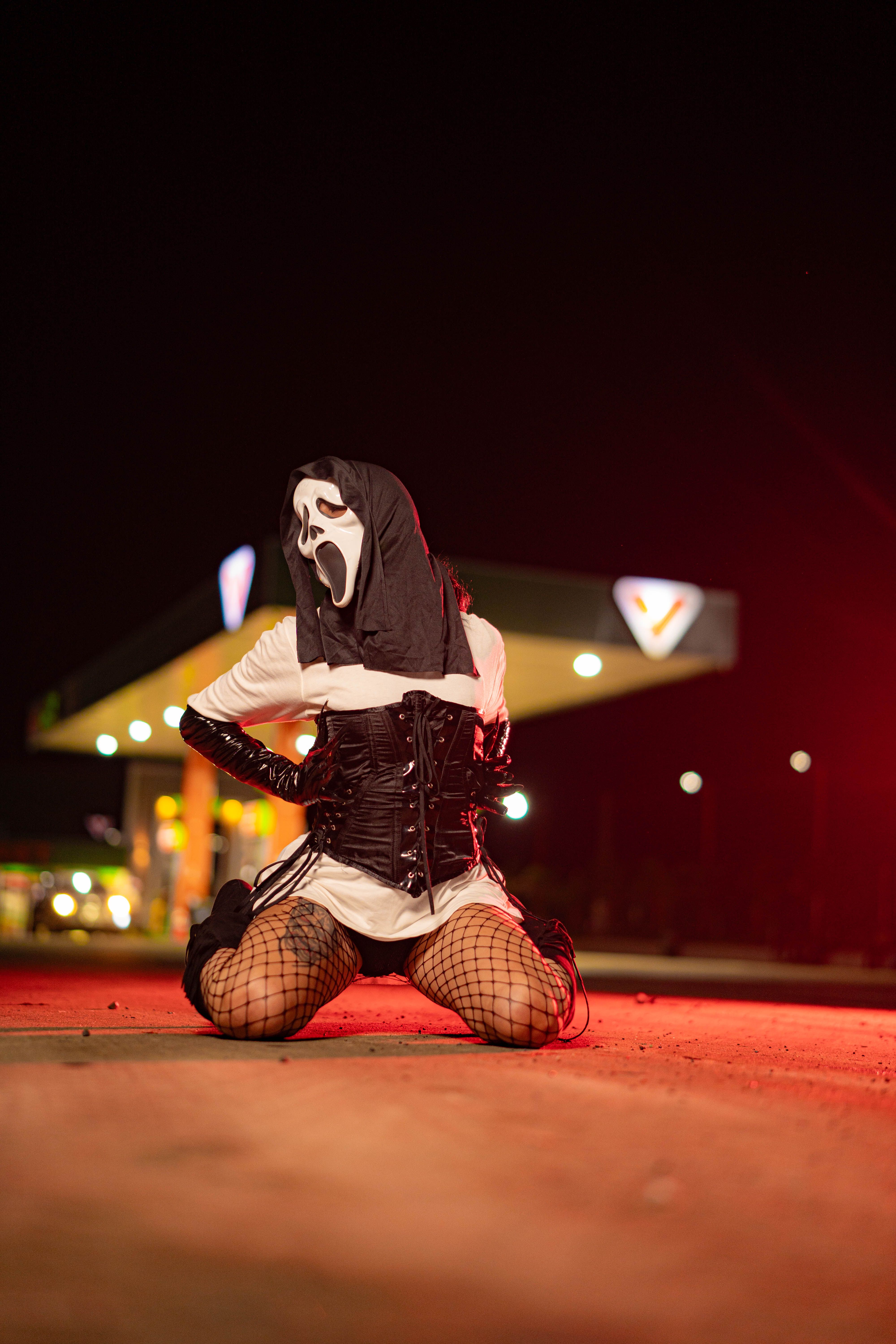Masked Performer at Night in Urban Setting · Free Stock Photo