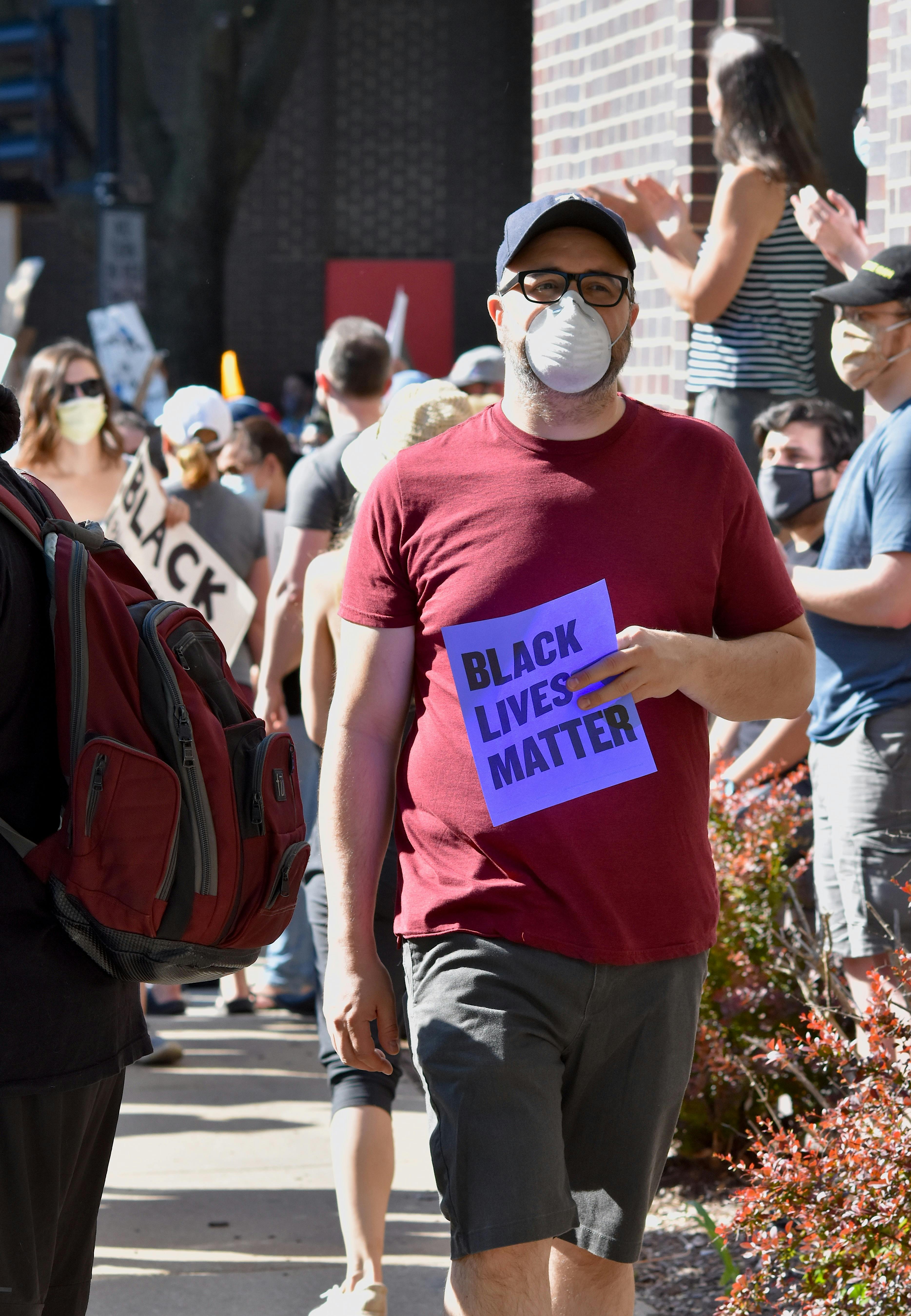 Man Holding BLM Sign at Sidewalk Protest · Free Stock Photo