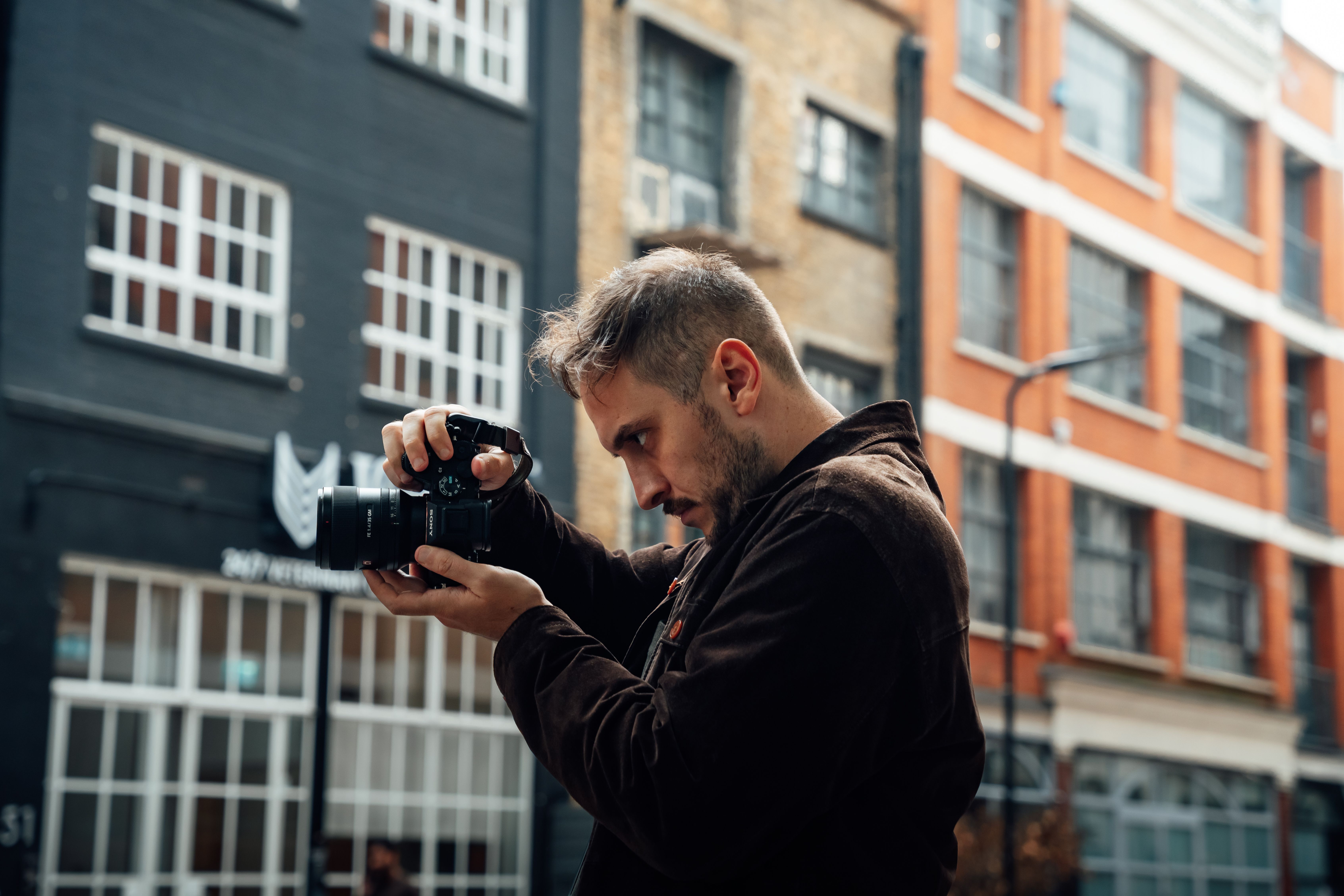 Street Photographer Focusing in London Scene · Free Stock Photo