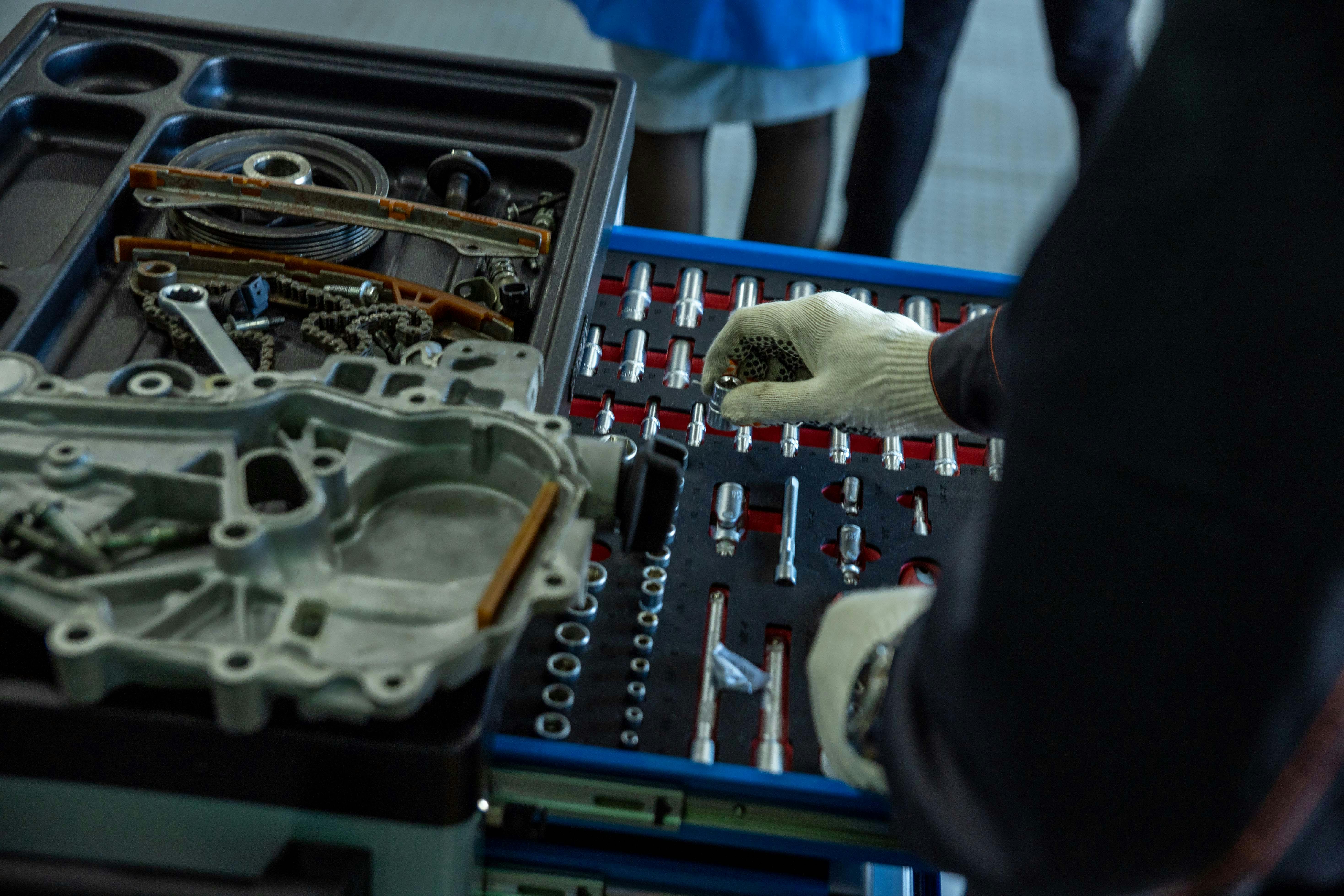 Mechanic Organizing Engine Components in Workshop · Free Stock Photo