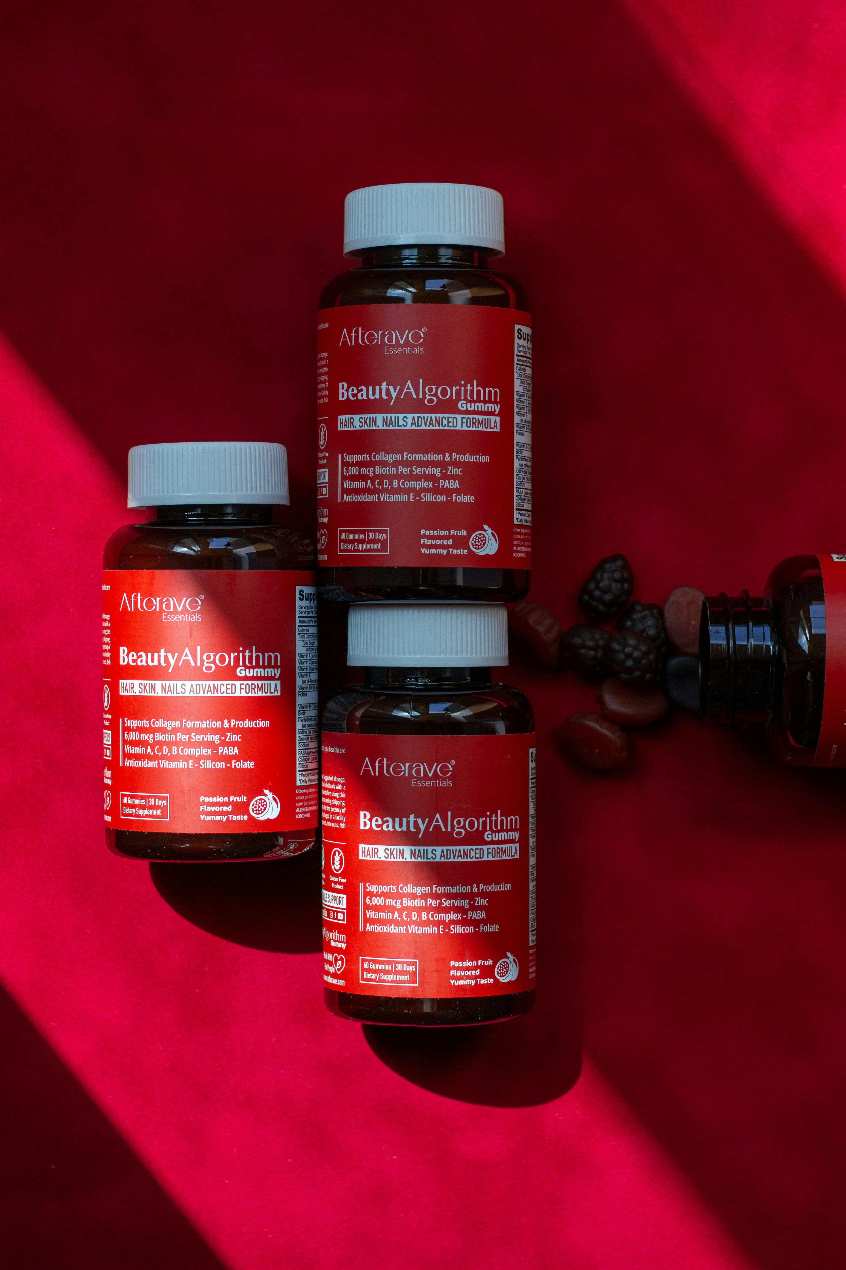 Red Beauty Algorithm Bottle Against Bold Background · Free Stock Photo