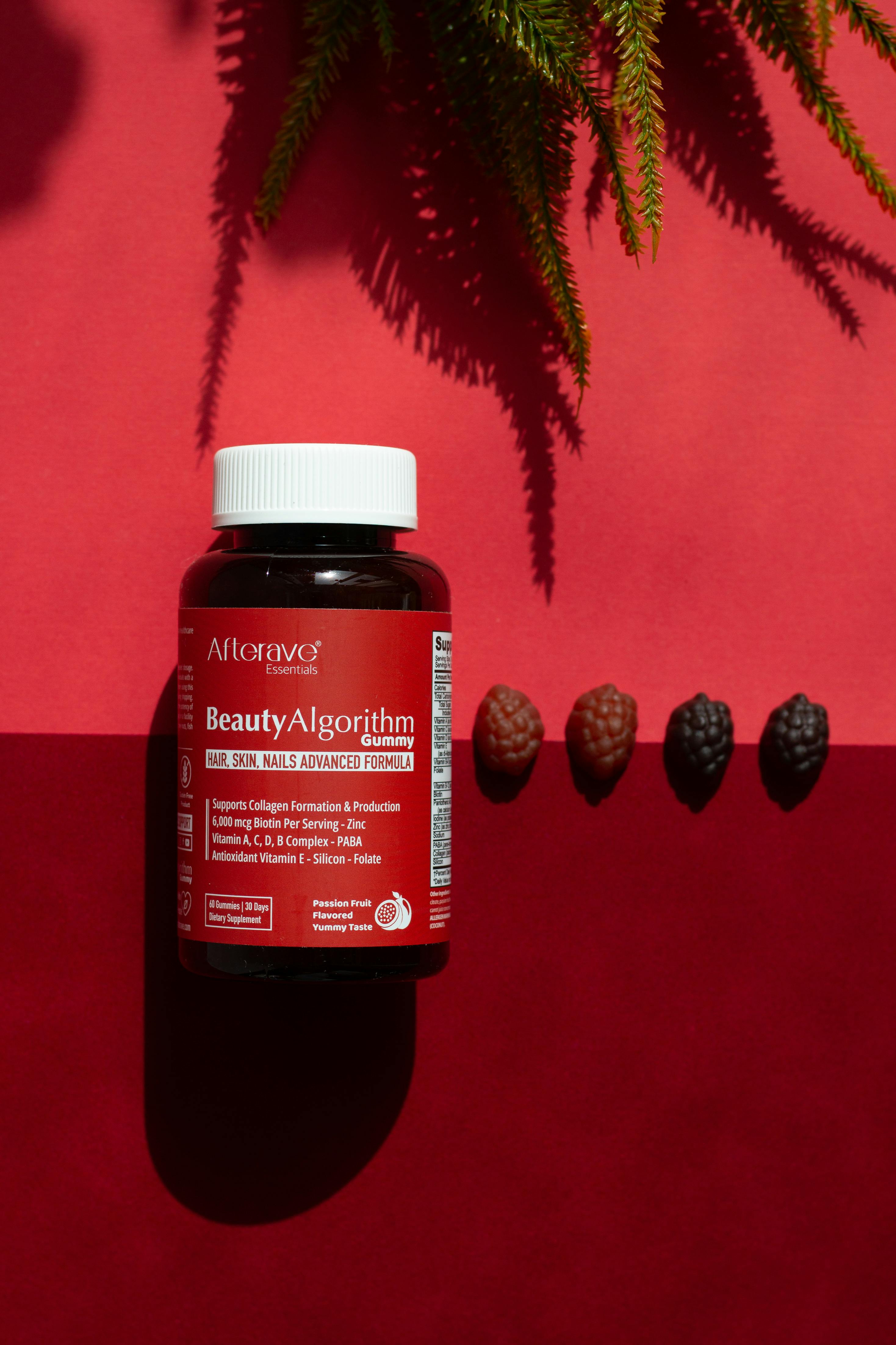 Biotin Supplement Bottle on Red Background · Free Stock Photo