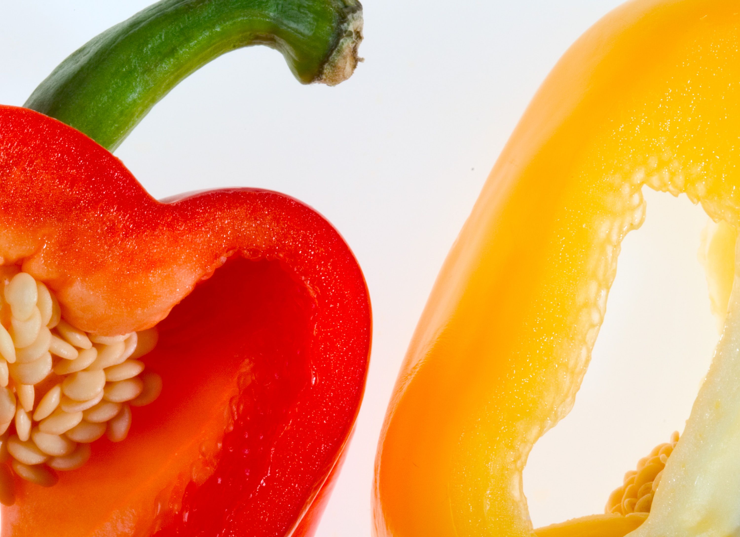 Close-Up of Sliced Bell Peppers on White Background · Free Stock Photo