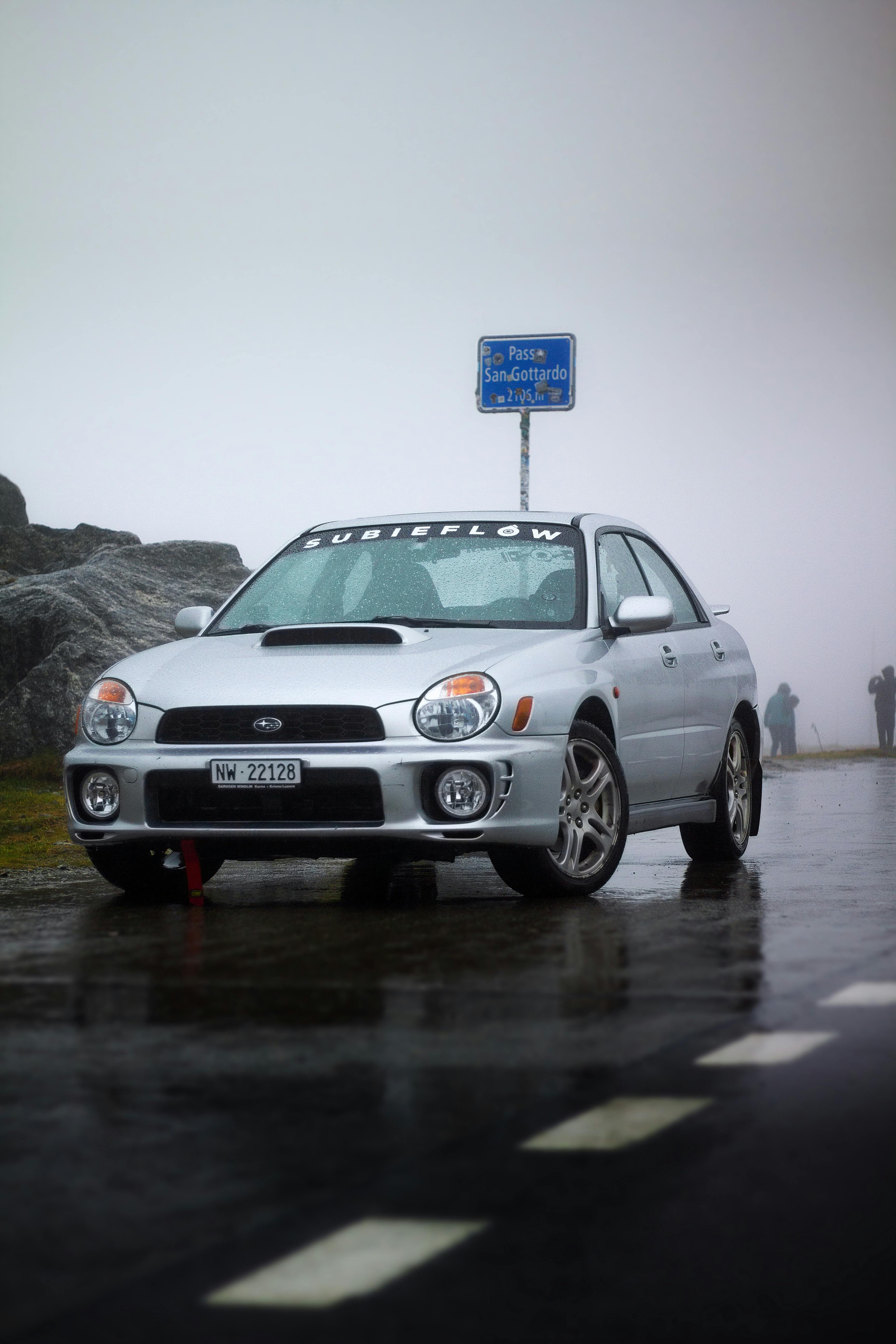 Silver Rally Car in Misty Mountain Pass · Free Stock Photo