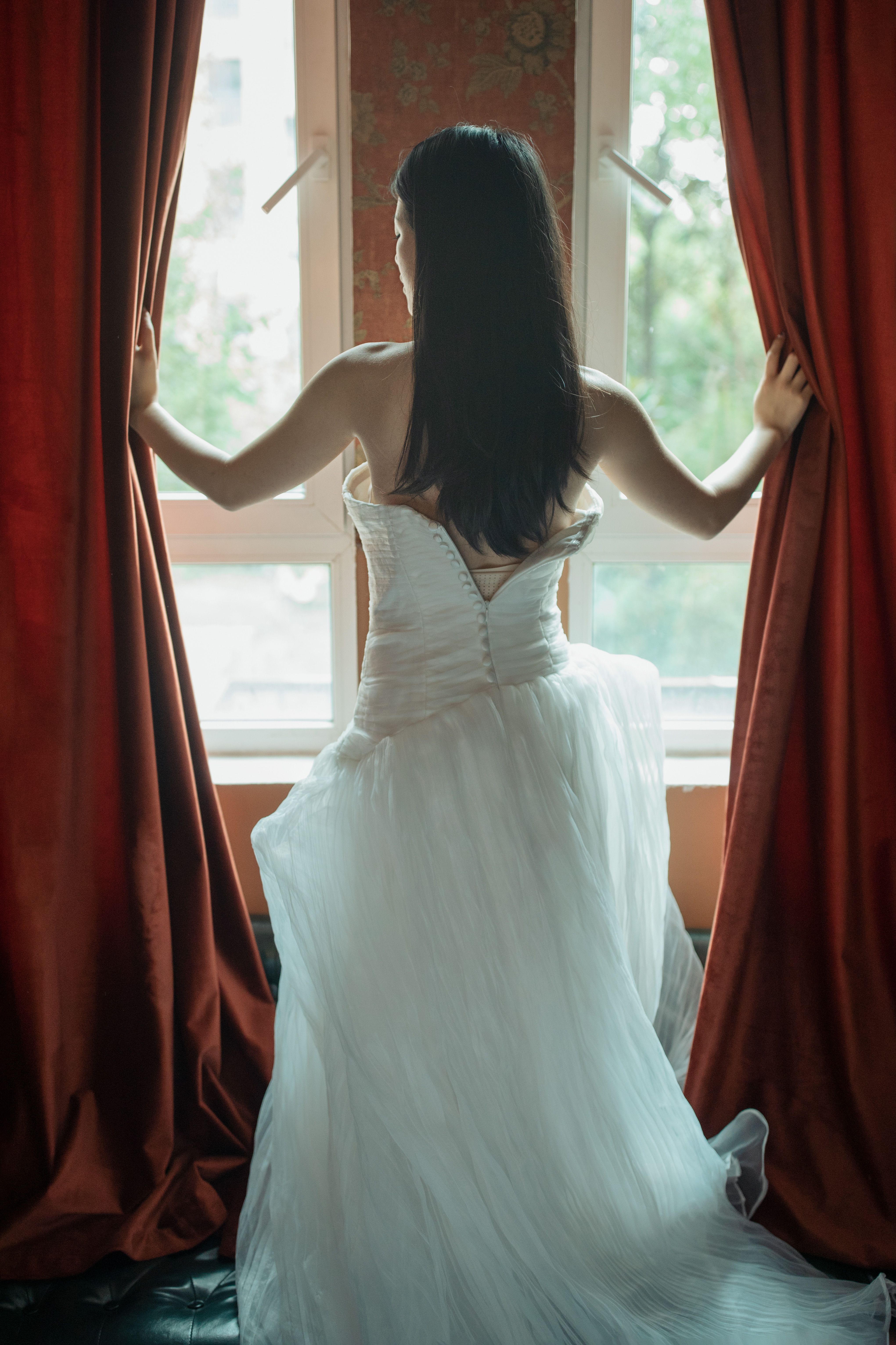 Bride in Elegant Gown Looking Out Window · Free Stock Photo