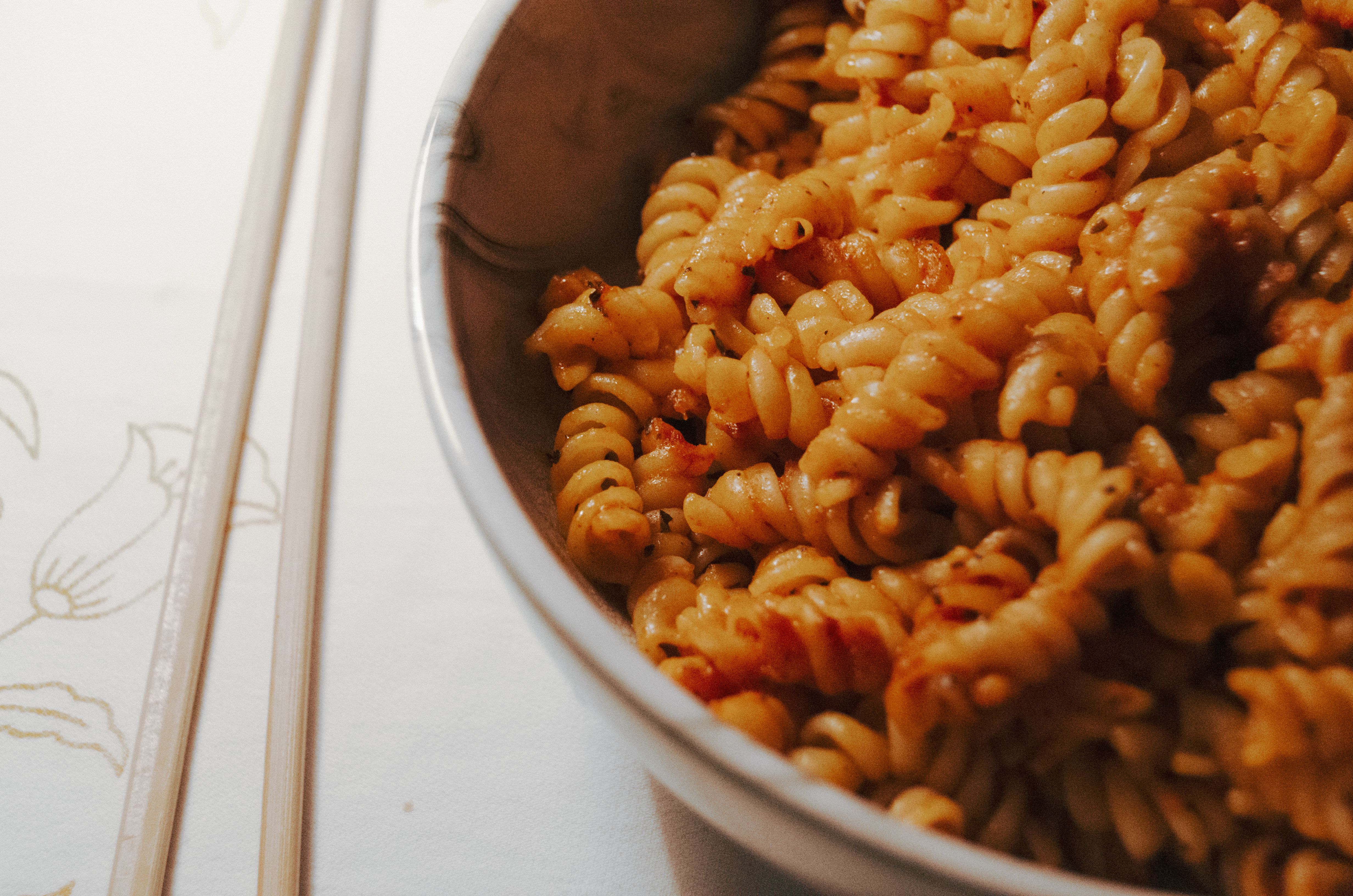 Delicious Spiral Pasta in Bowl with Chopsticks · Free Stock Photo