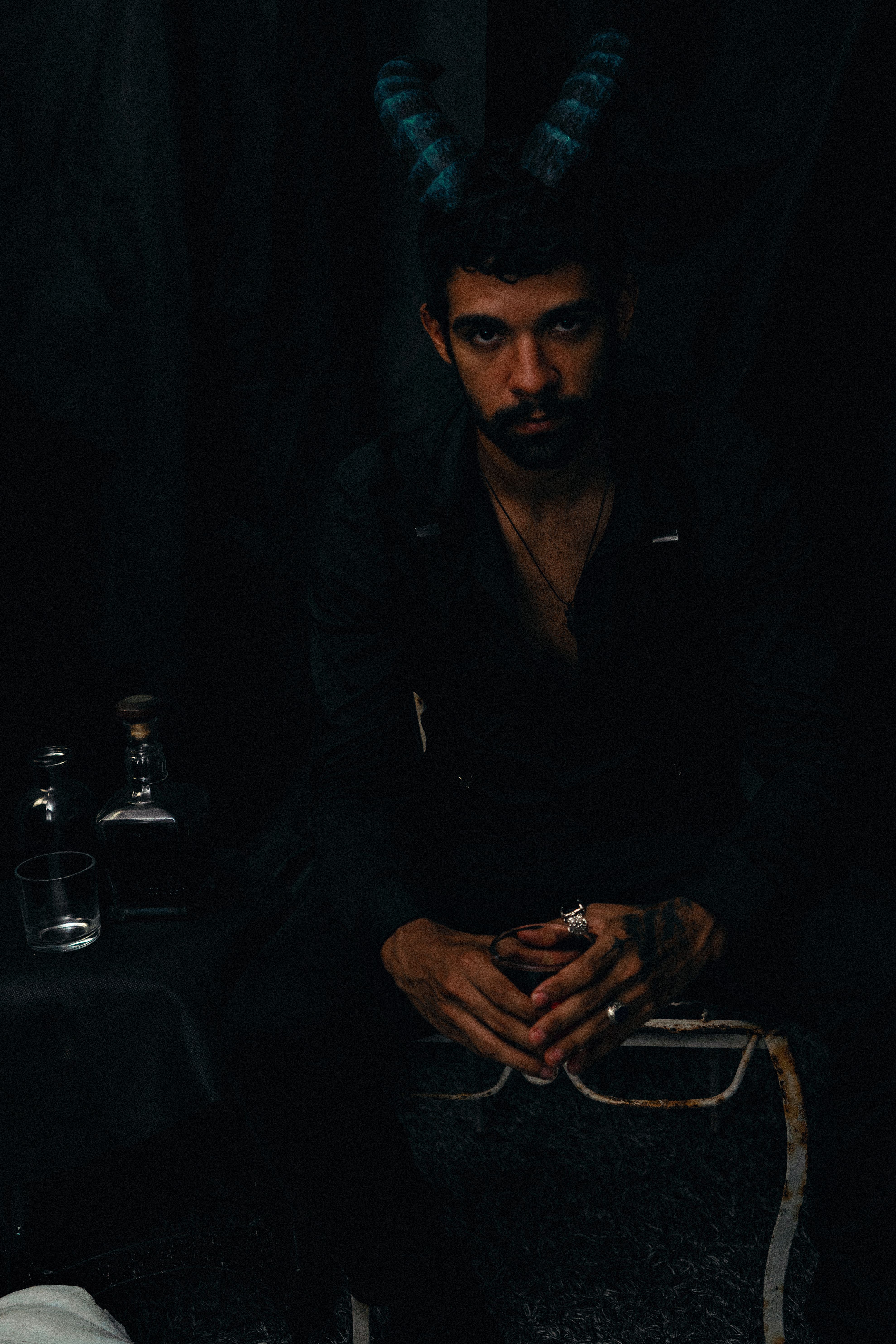 Mysterious Man with Horns in Dark Setting · Free Stock Photo