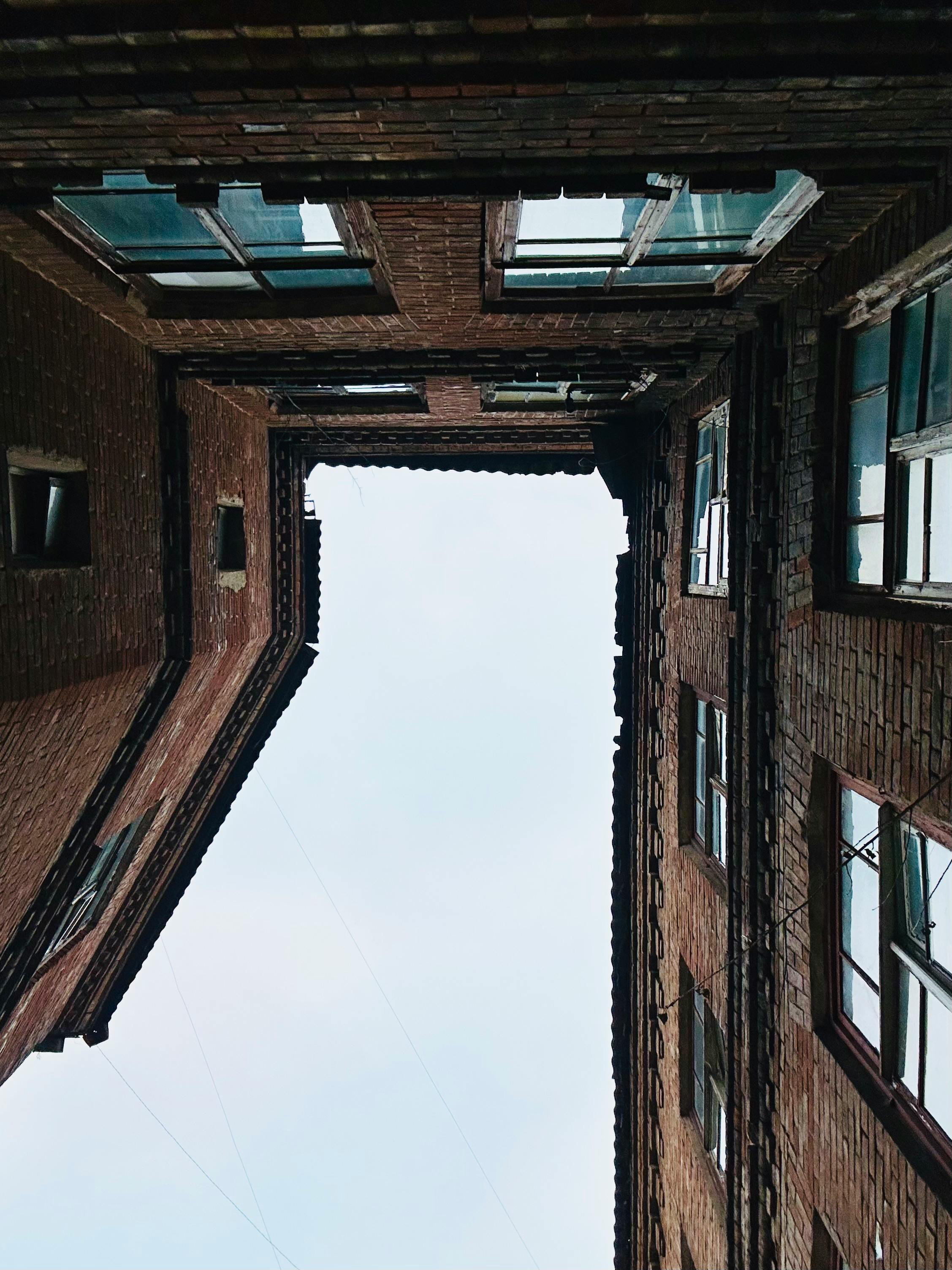 Upward View of Narrow Urban Building Alley · Free Stock Photo