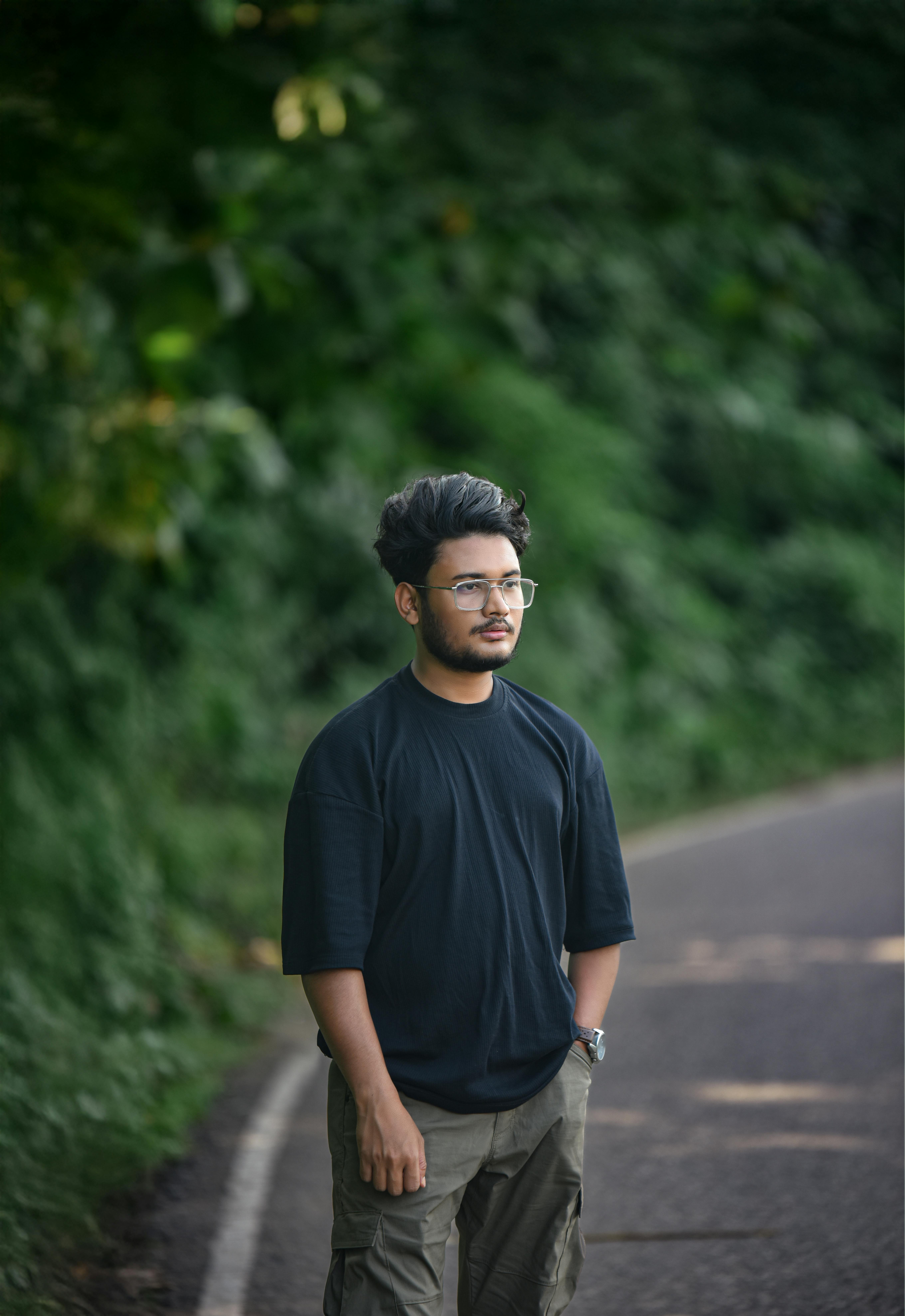 Young Man Strolling on a Leafy Roadside in Bangladesh · Free Stock Photo