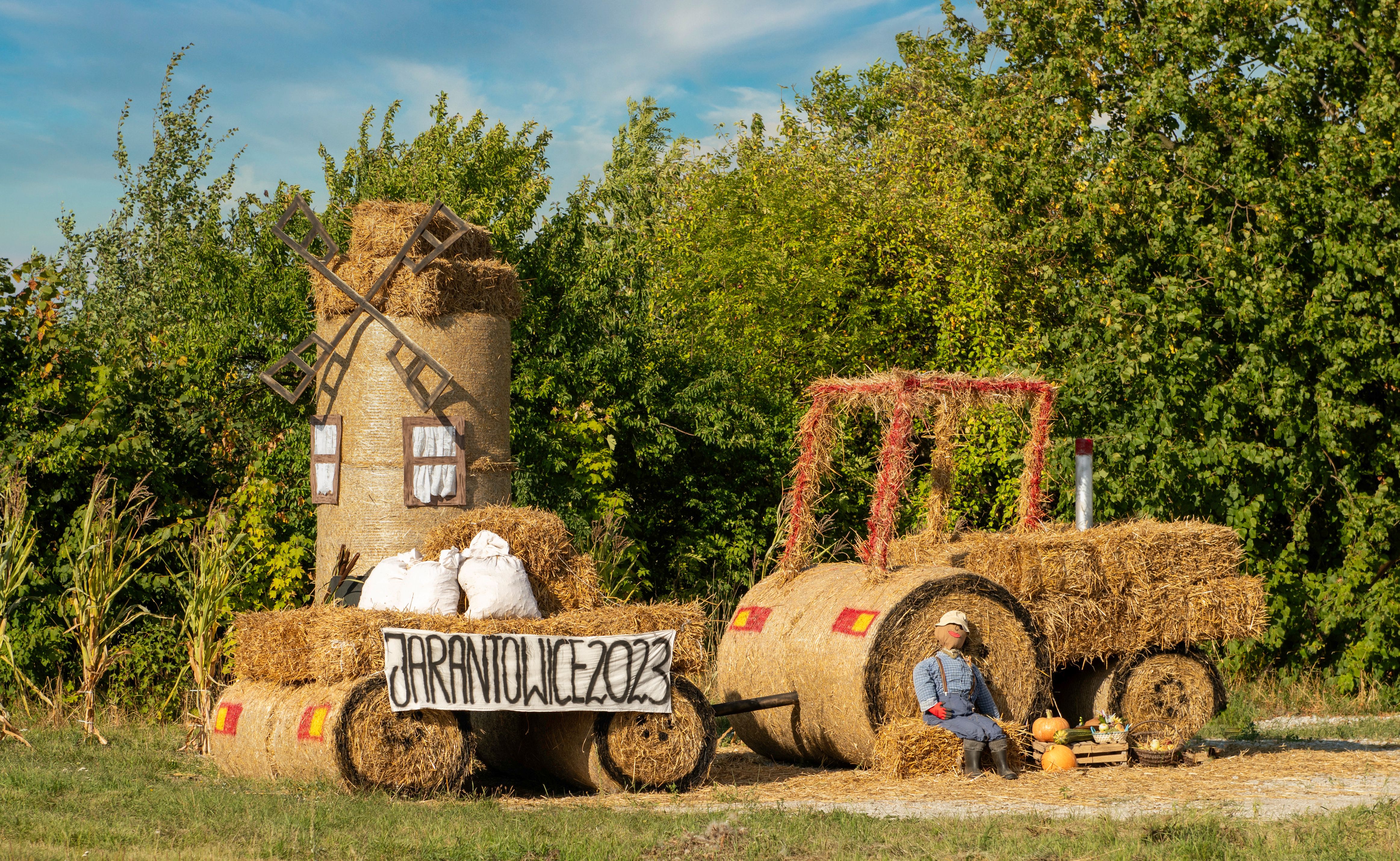 Hay Bale Art Display with Windmill and Tractor · Free Stock Photo