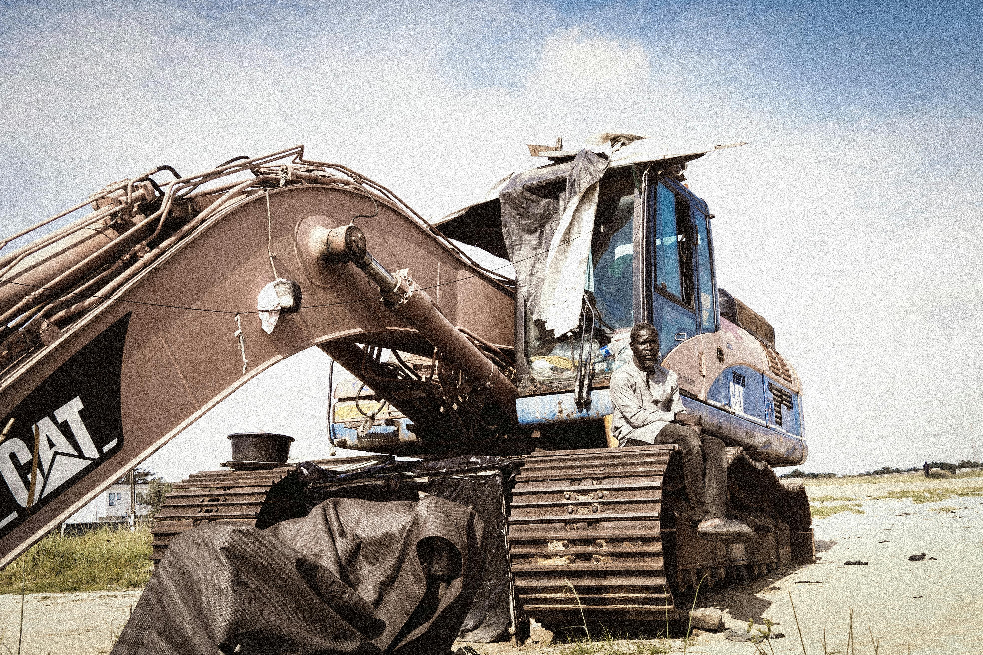 Man Sitting on Excavator in Lagos, Nigeria · Free Stock Photo
