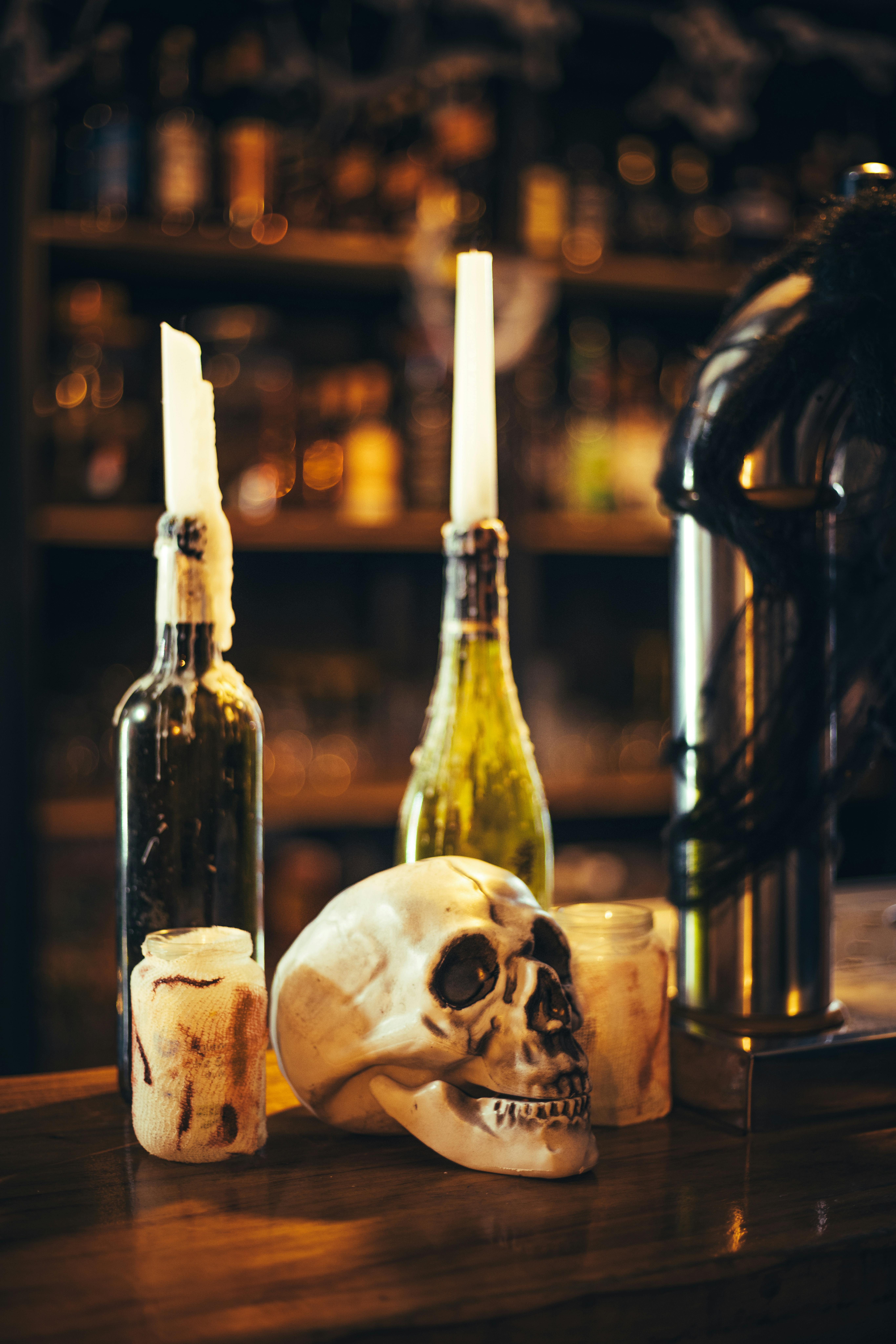 Spooky Halloween Bar Decor with Skull and Candles · Free Stock Photo