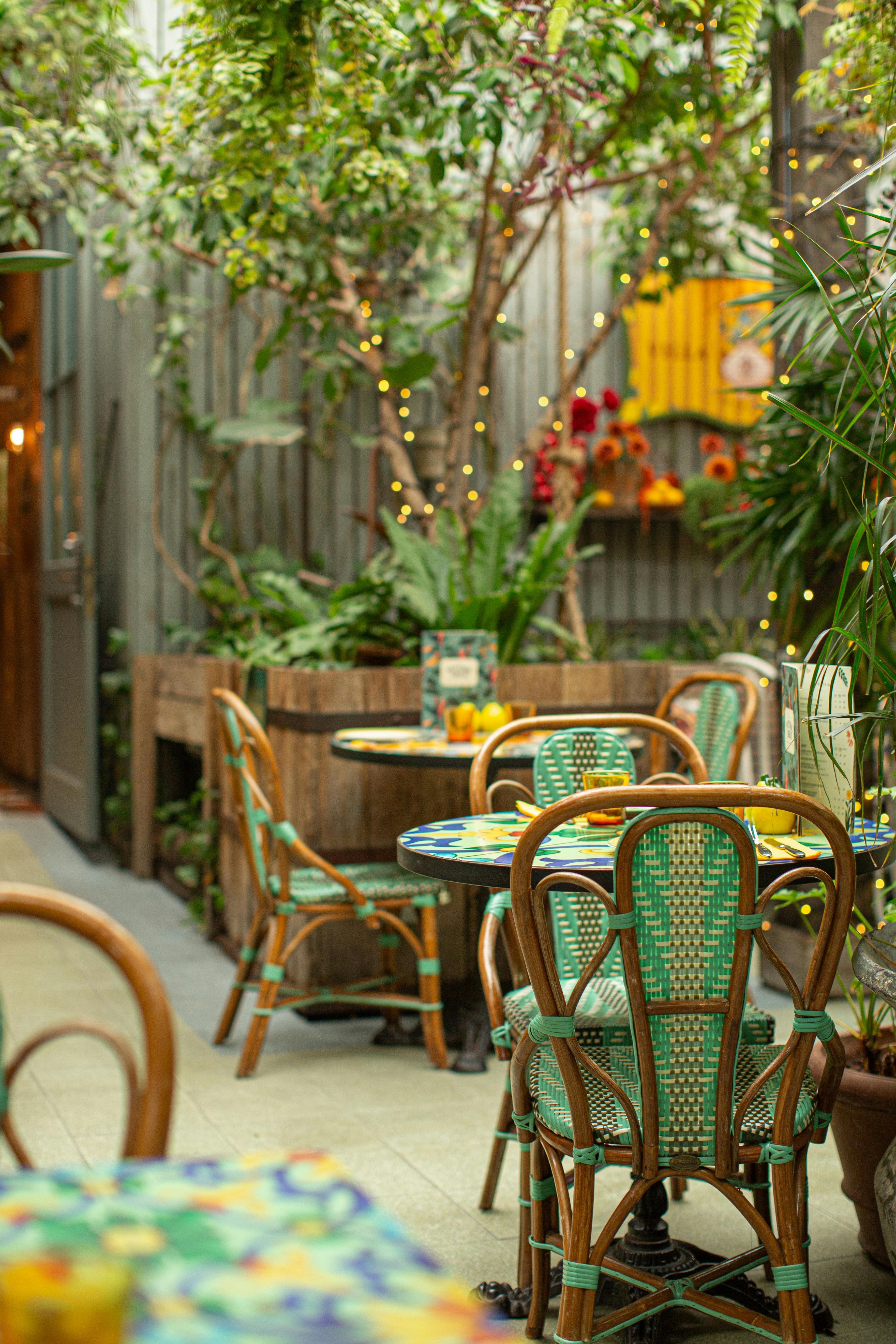 Charming Outdoor Cafe Seating in Lush Garden · Free Stock Photo