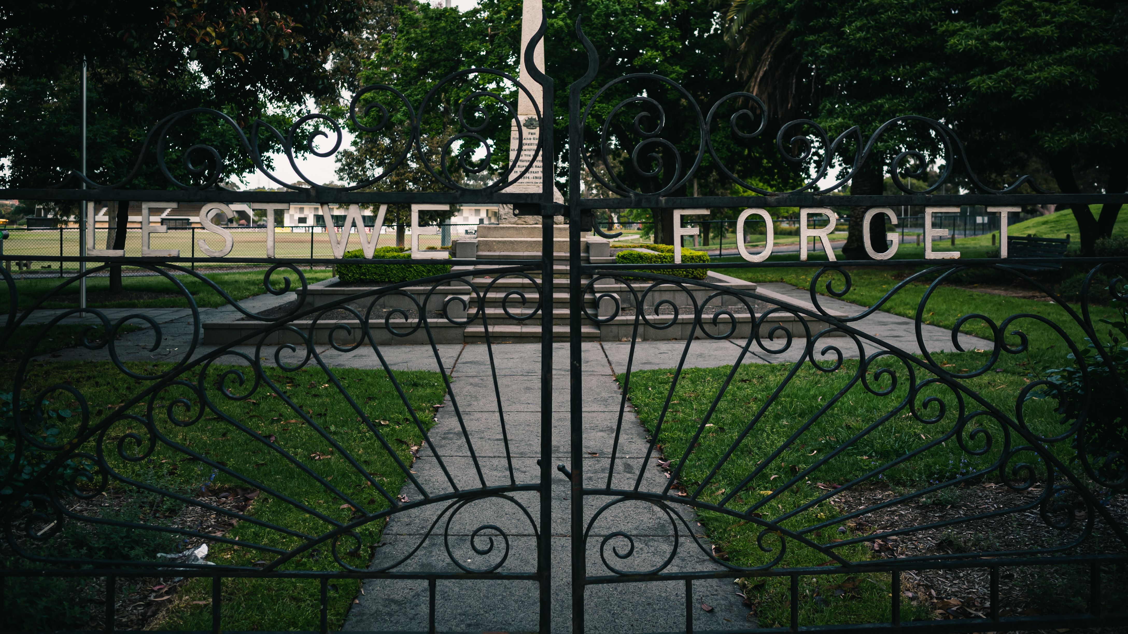 Decorative Iron Gate with 'Lest We Forget' Inscription · Free Stock Photo