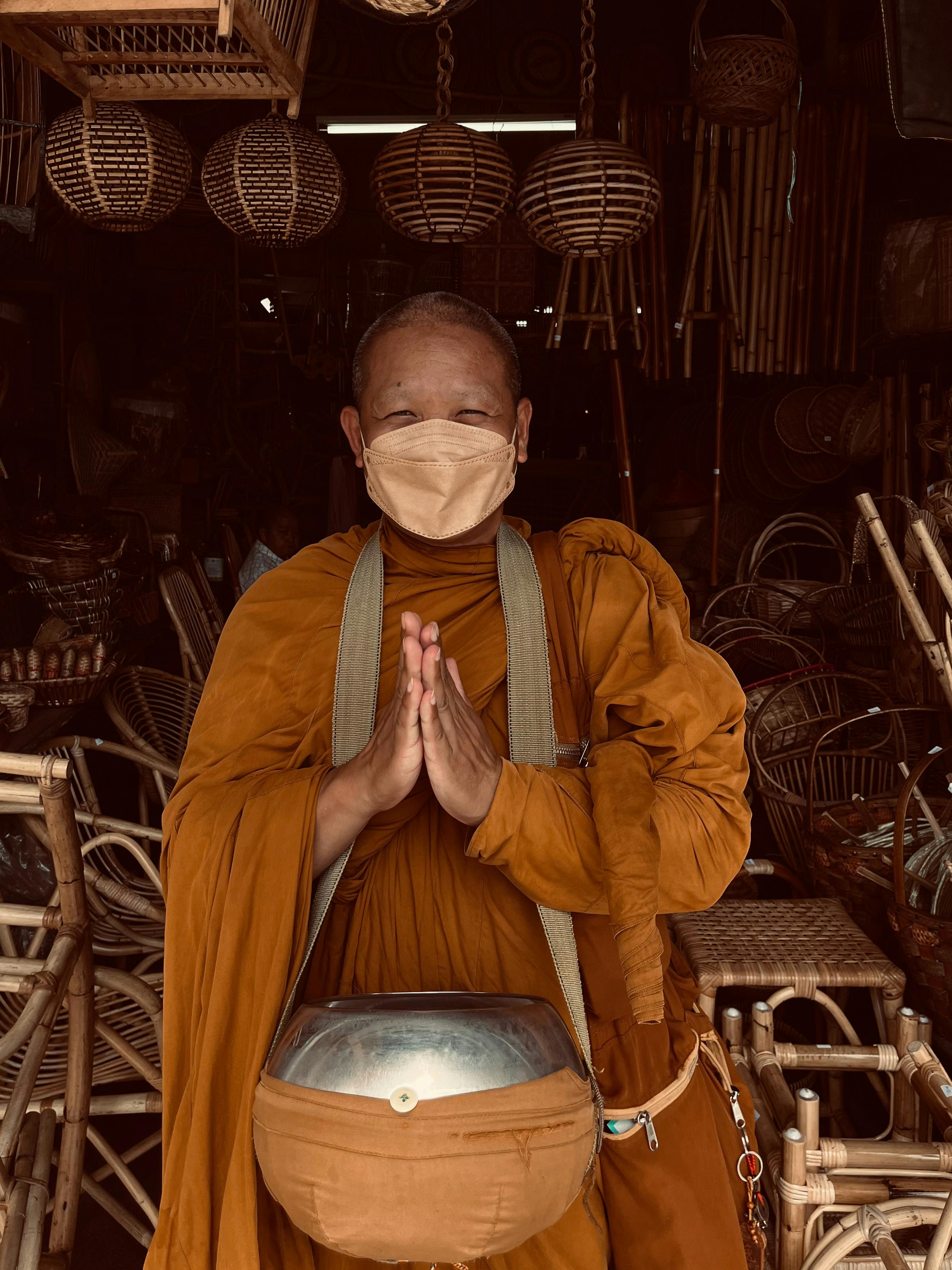 Buddhist Monk in Traditional Robes with Offering Bowl · Free Stock Photo