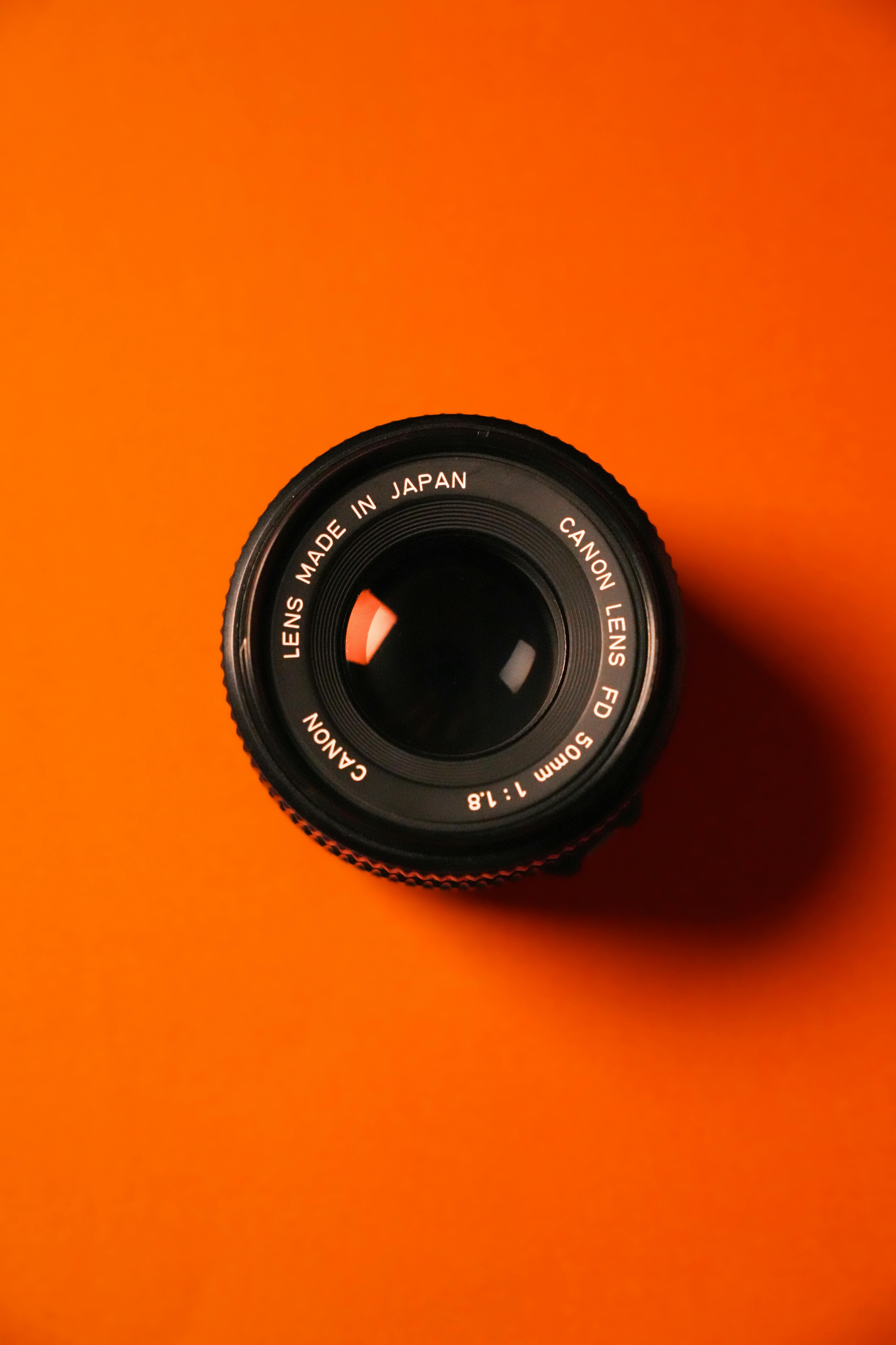 Vintage Camera Lens on Vibrant Orange Background · Free Stock Photo