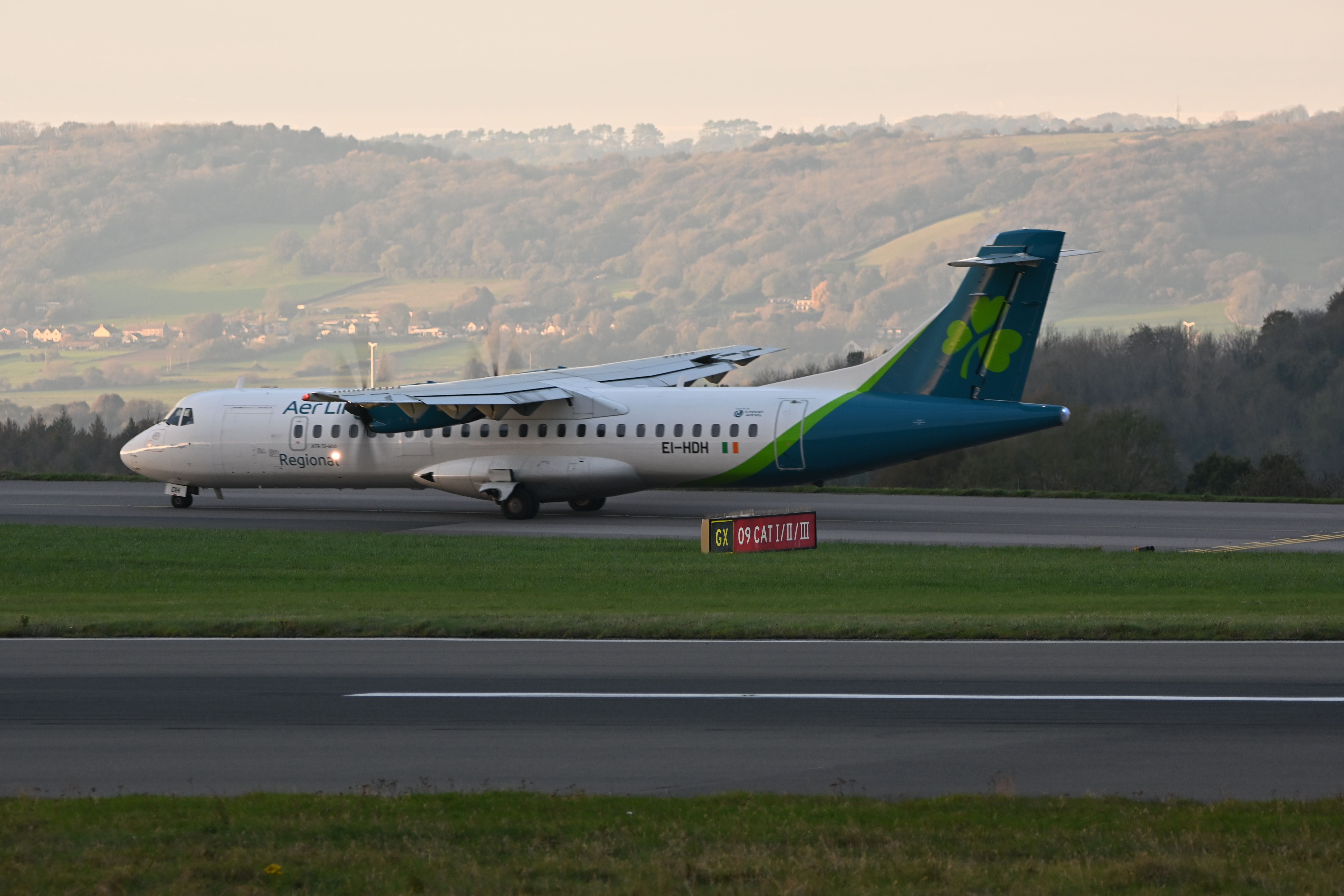 Aer Lingus Regional Aircraft on Runway at Sunset · Free Stock Photo
