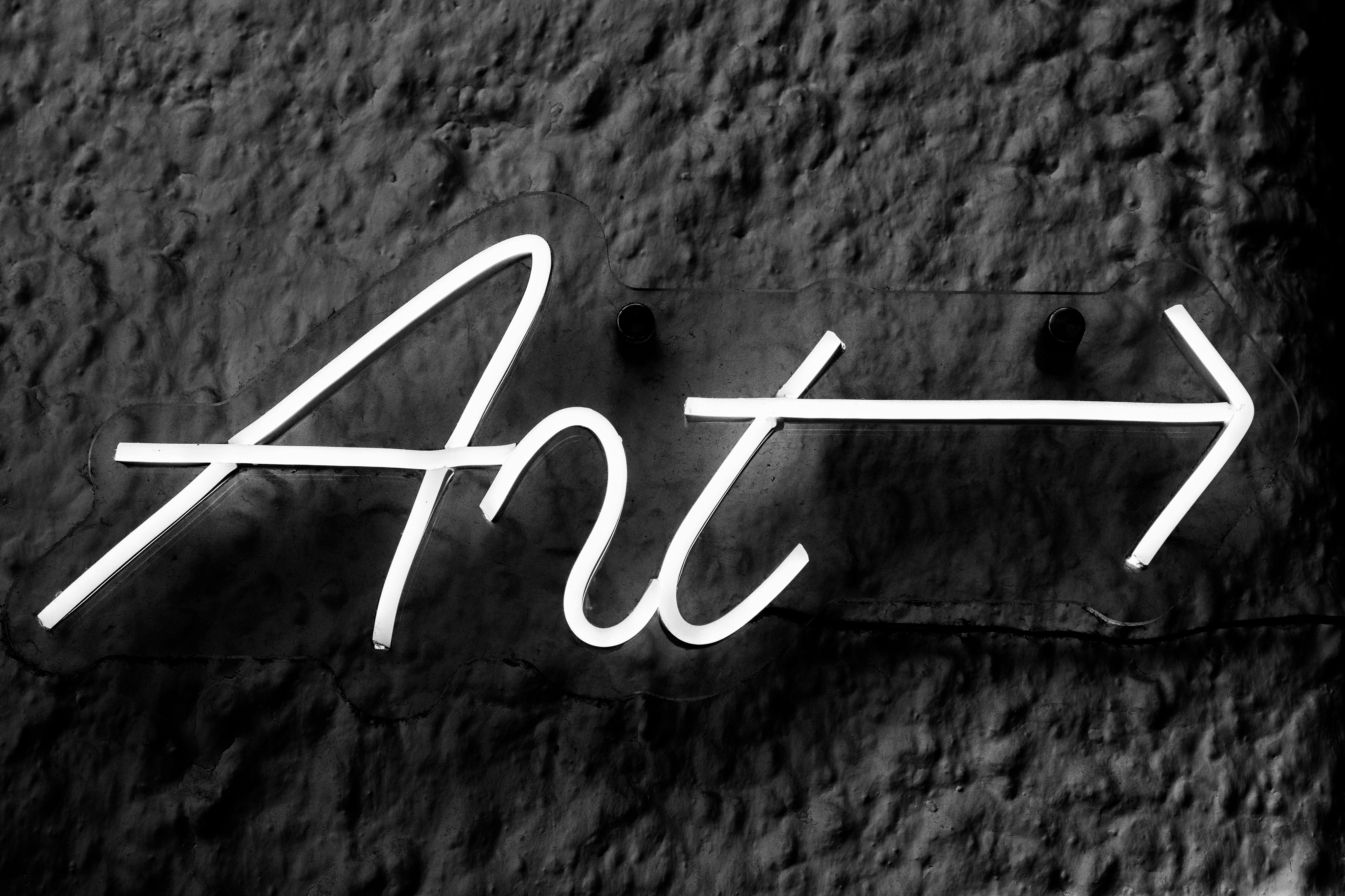 Black and White Neon Art Sign on Textured Wall · Free Stock Photo