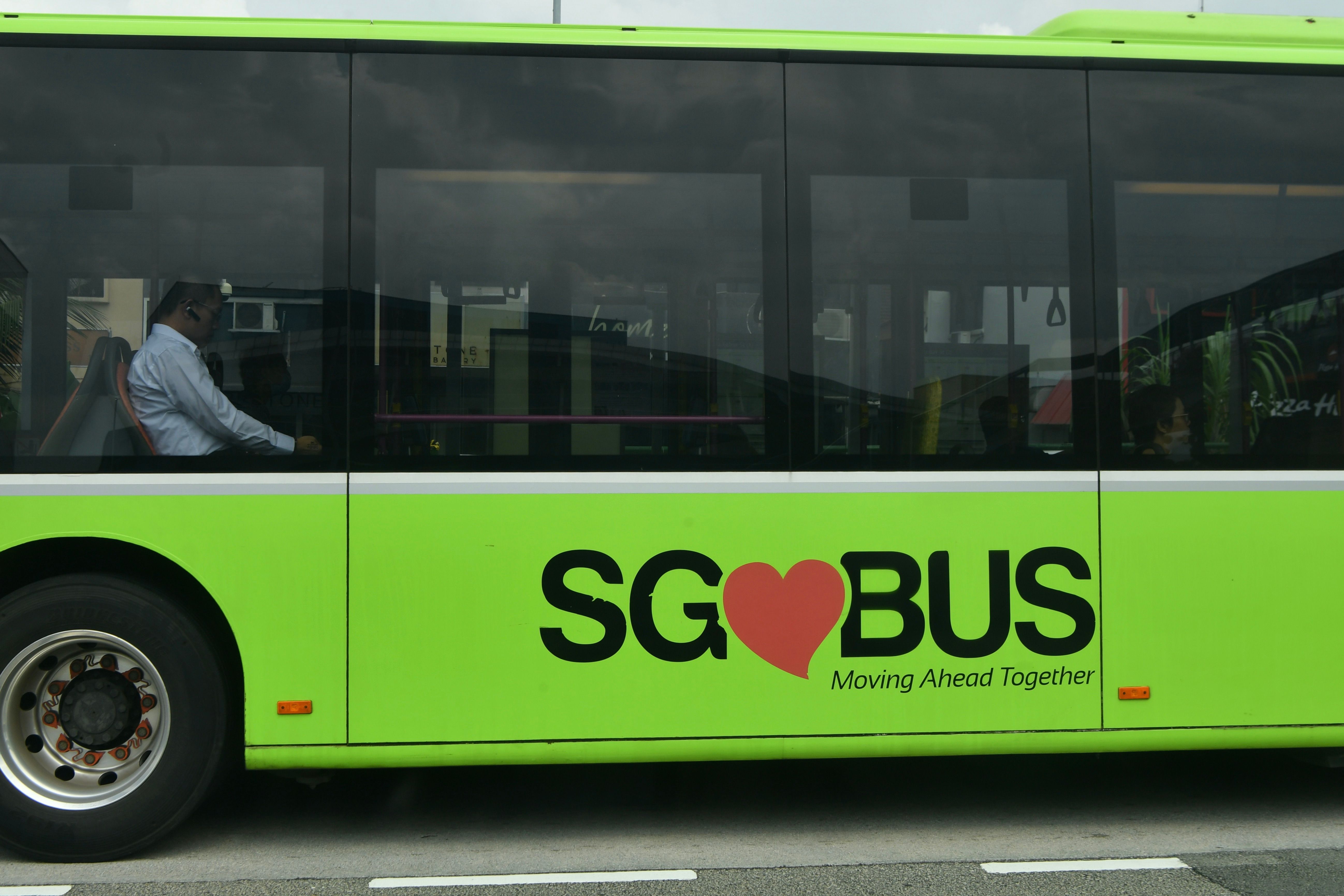 Singapore SG Bus in Motion with Passengers · Free Stock Photo