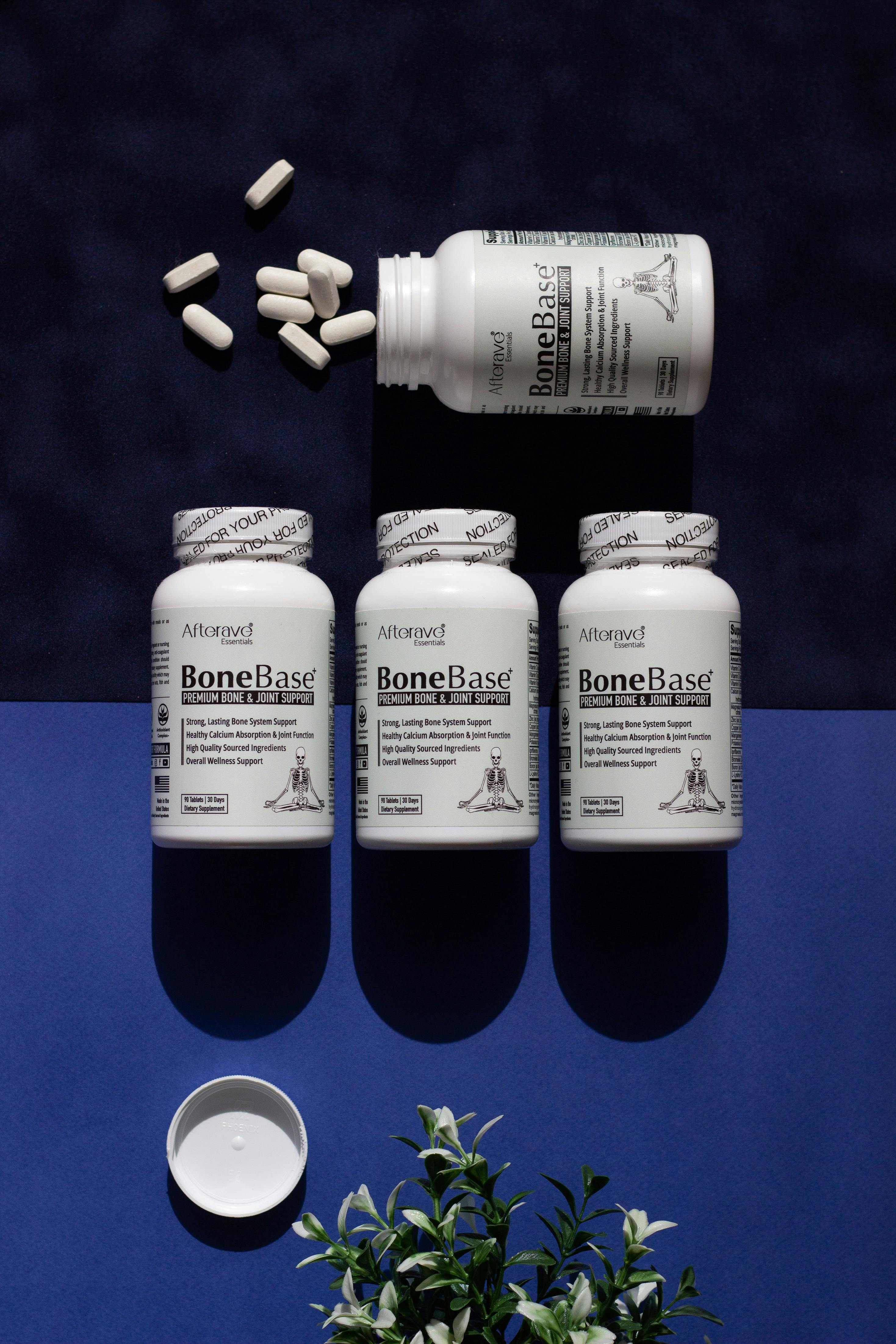 Bone Support Supplement Bottles on Blue Surface · Free Stock Photo