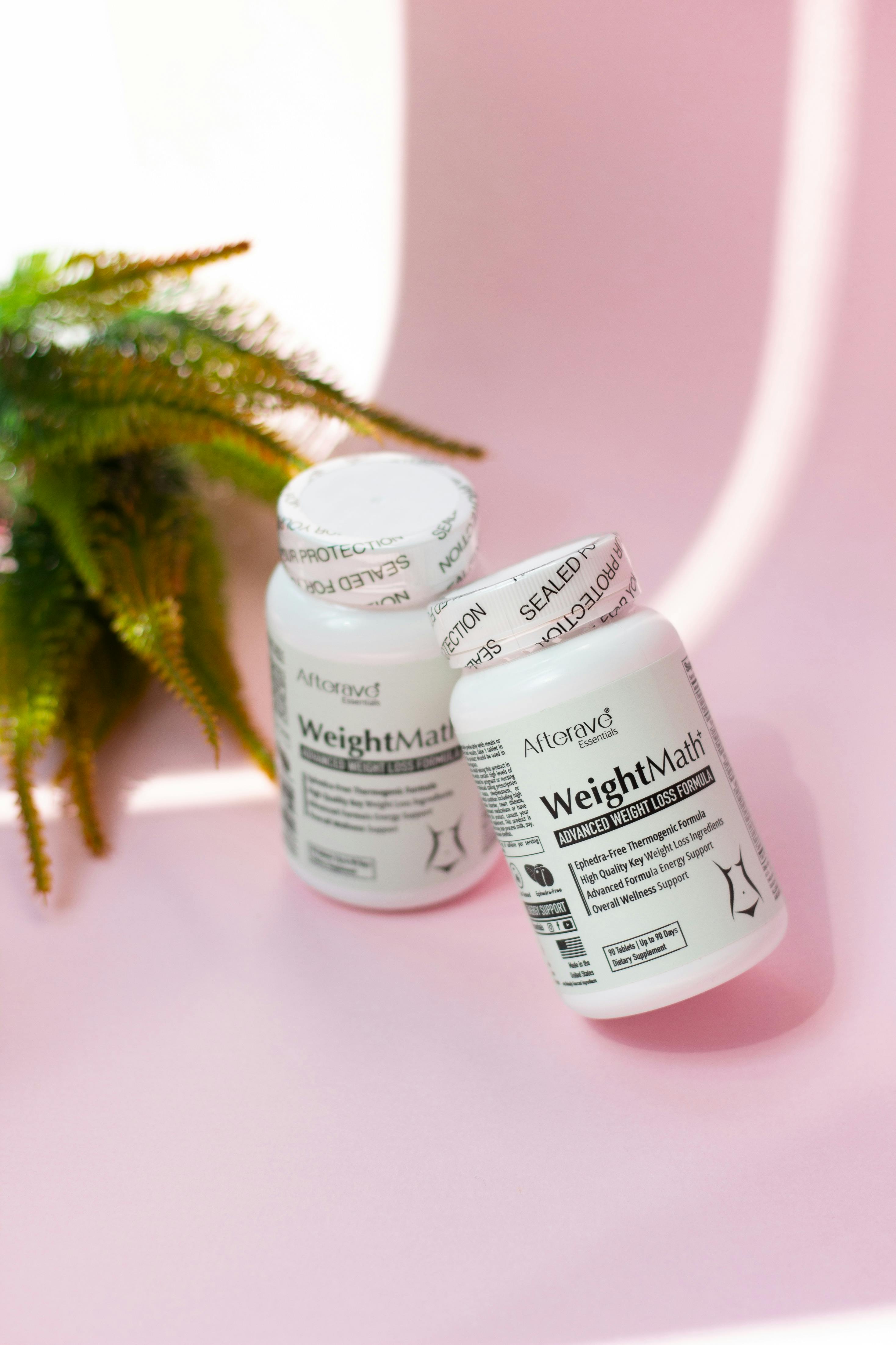 Weight Management Supplements on Pink Surface · Free Stock Photo