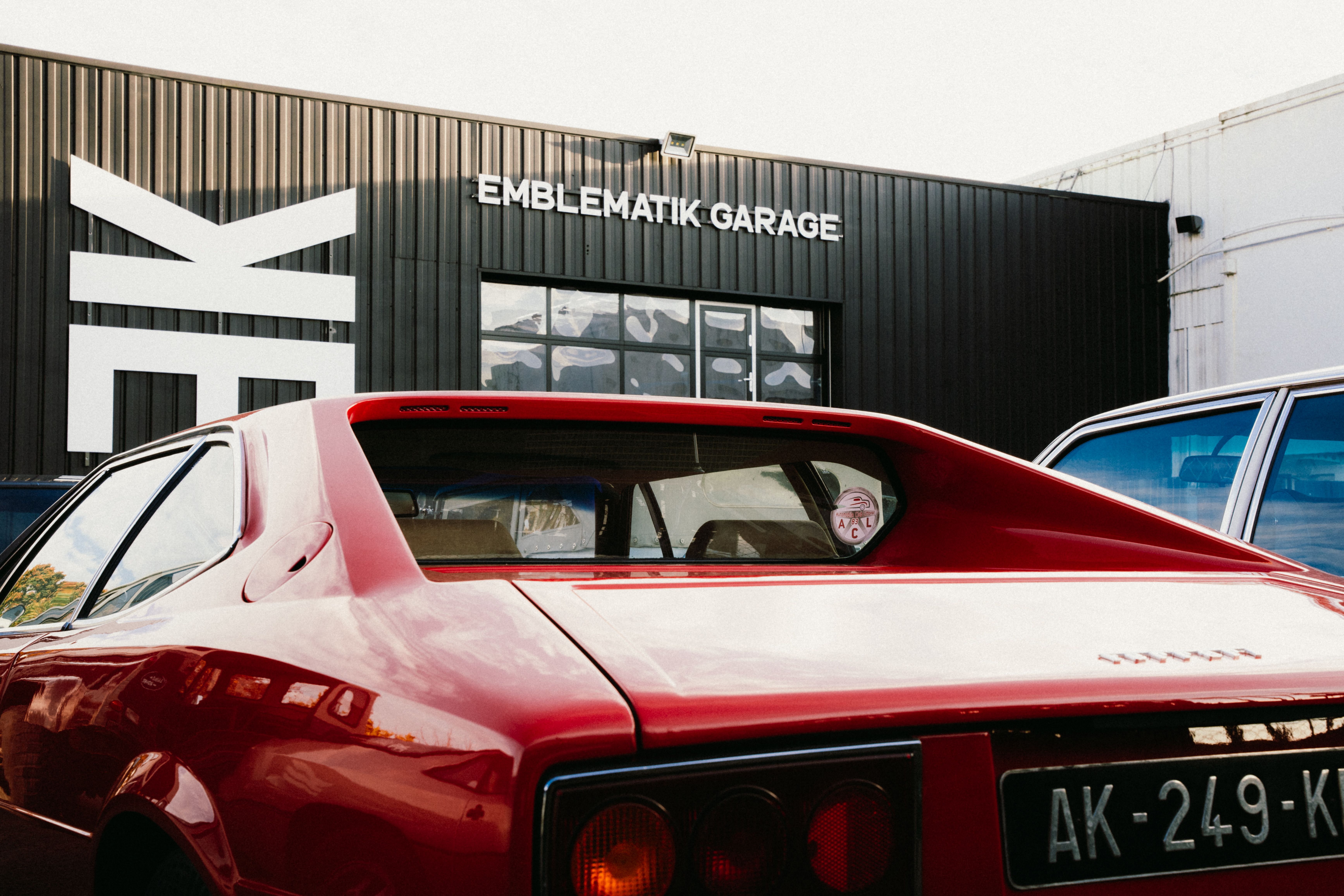 Classic Red Car at Emblematik Garage in France · Free Stock Photo