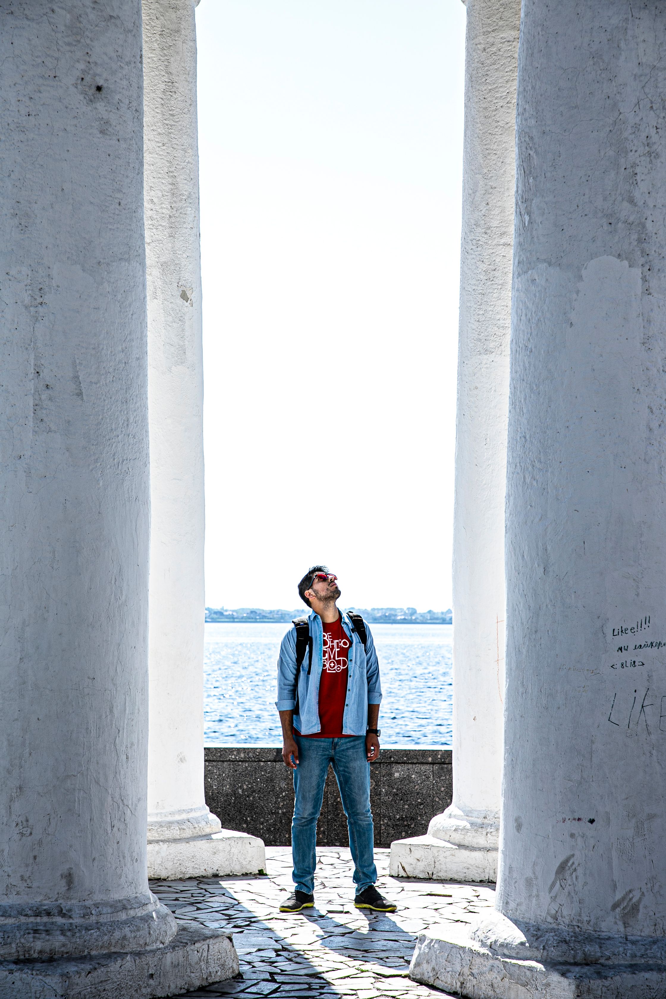Photo of Man Standing Between White Pillars · Free Stock Photo