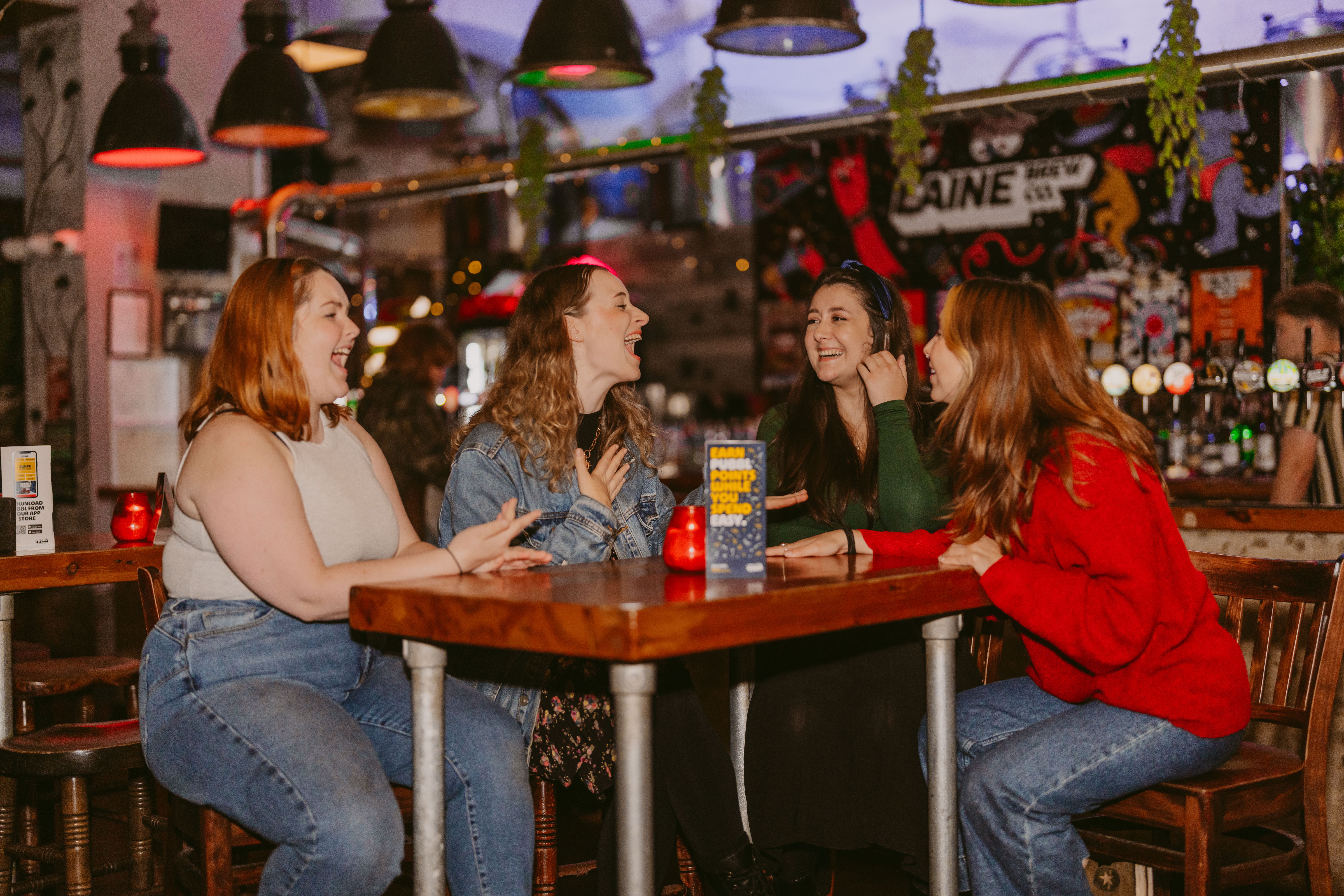 Group of Women Socializing in a Vibrant Cafe · Free Stock Photo