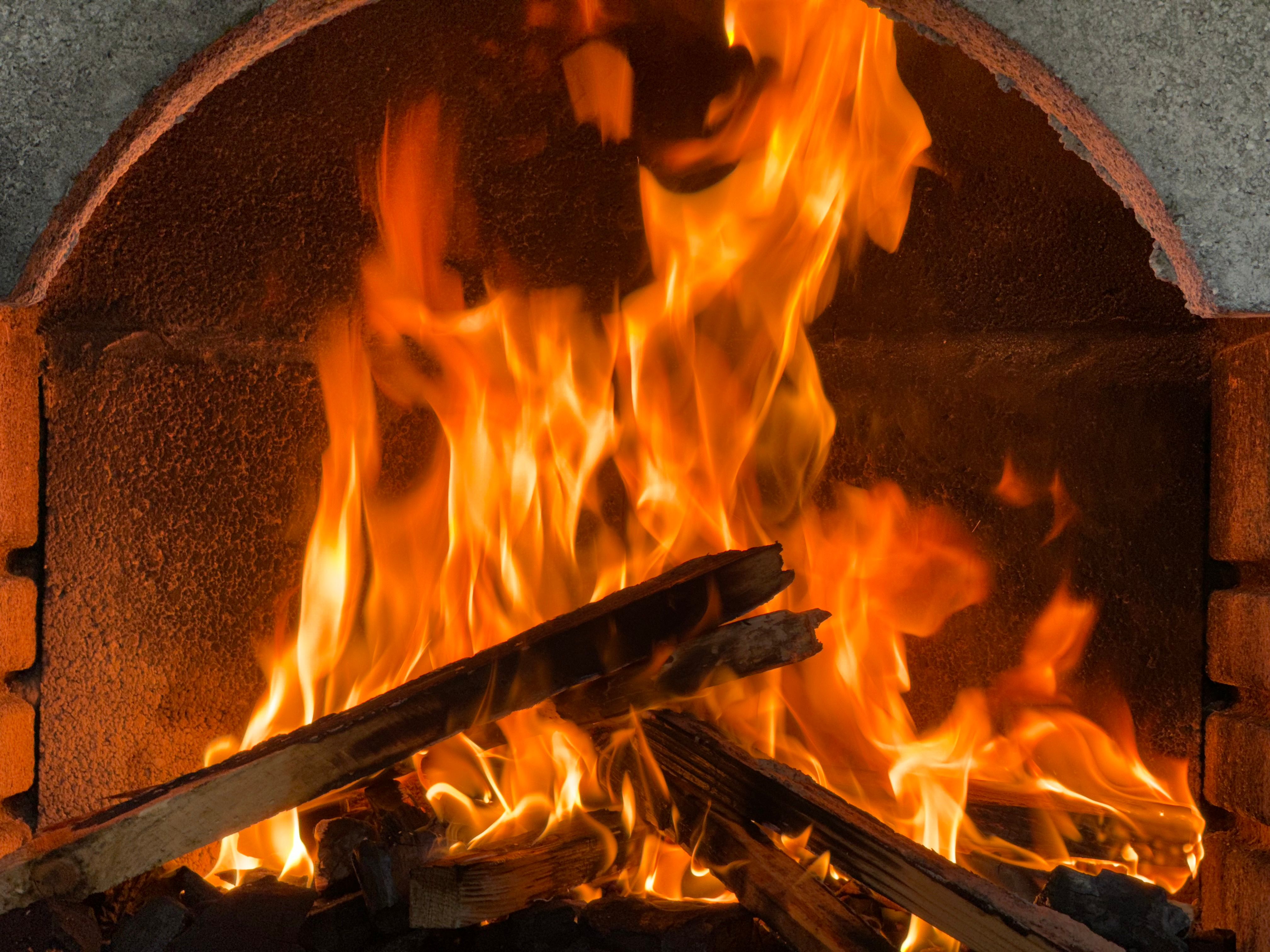 Vibrant Flames in Rustic Fireplace setting · Free Stock Photo