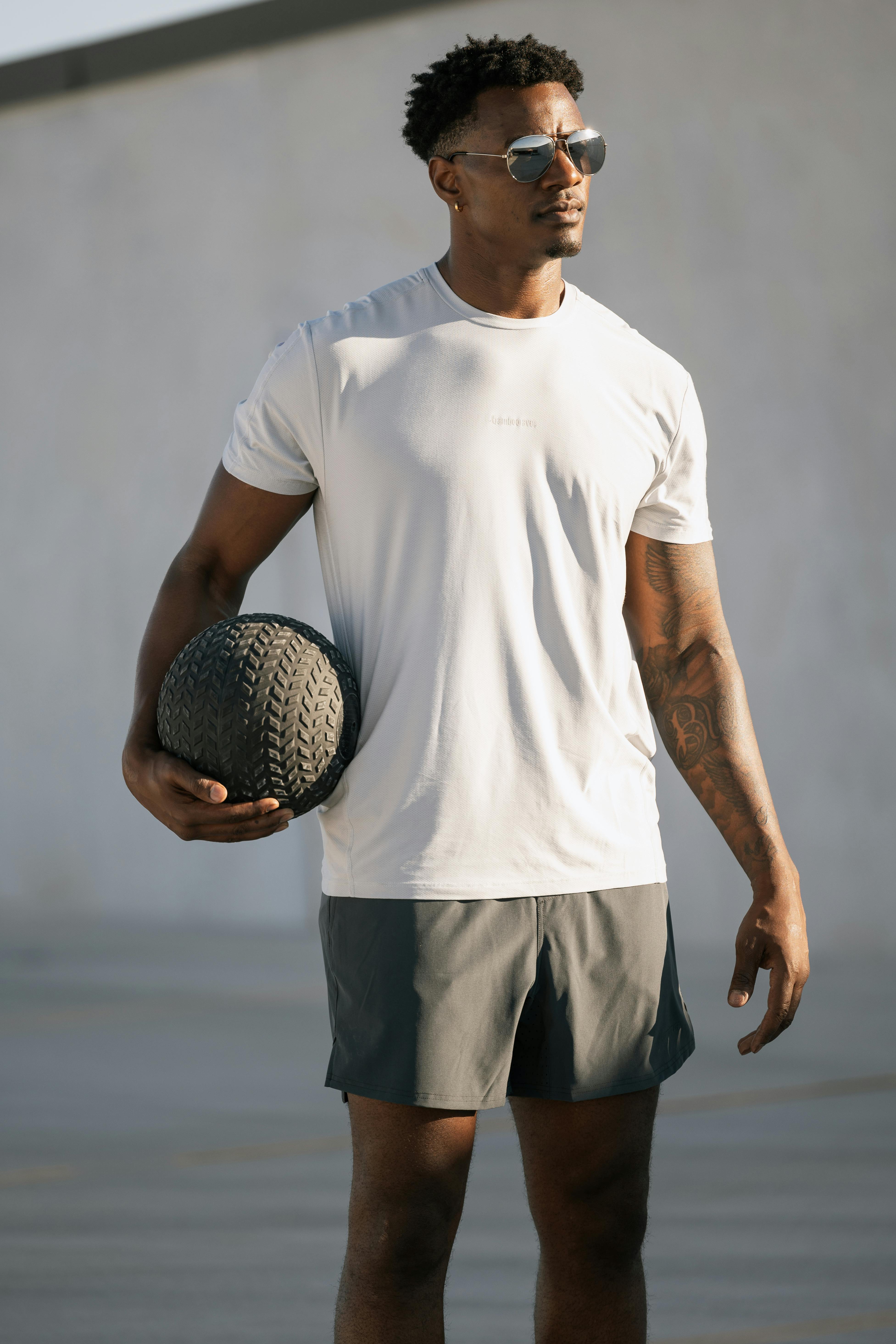 Athletic Male in Stylish Activewear on Rooftop · Free Stock Photo