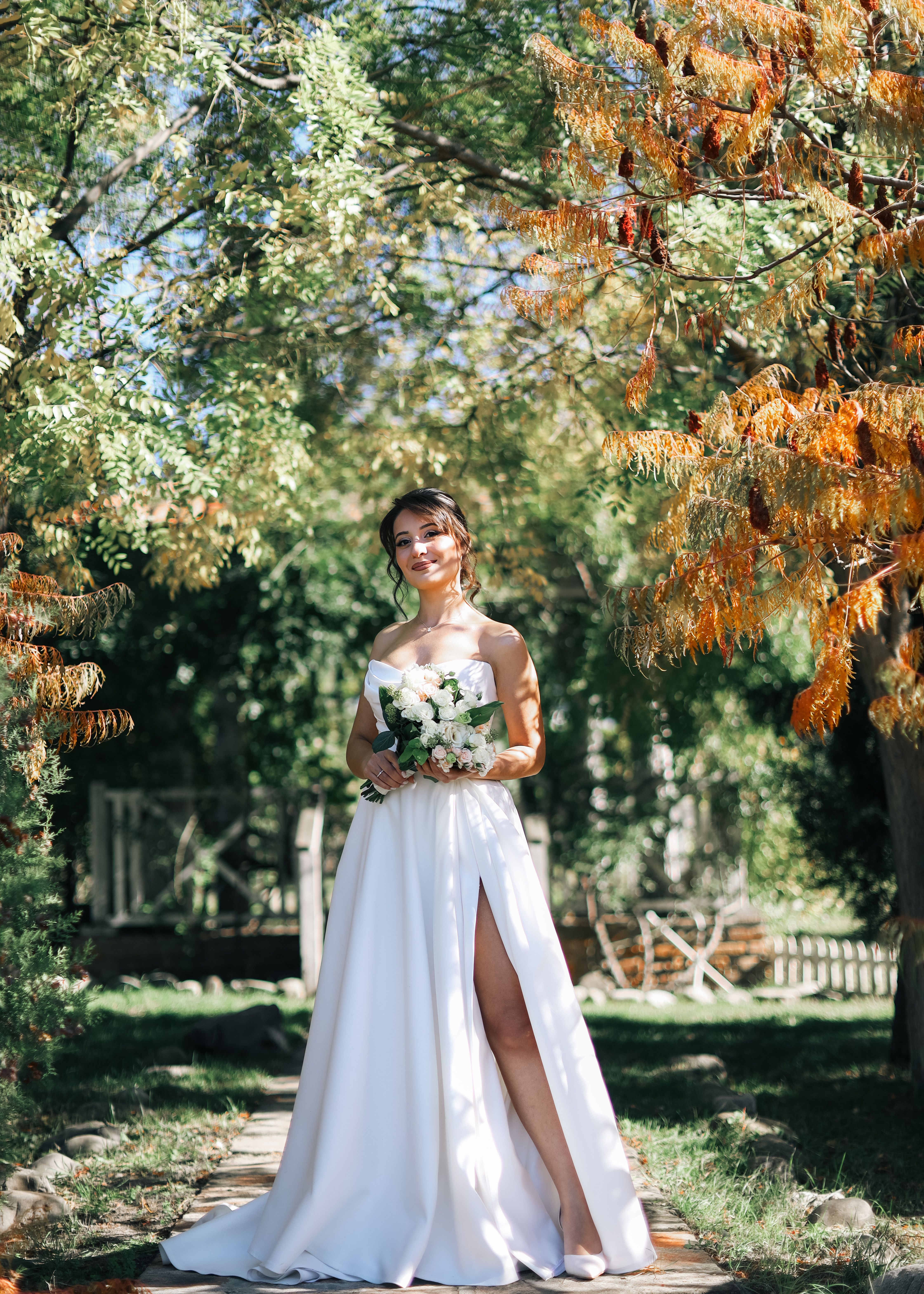Bride Posing Elegantly in Vibrant Garden · Free Stock Photo